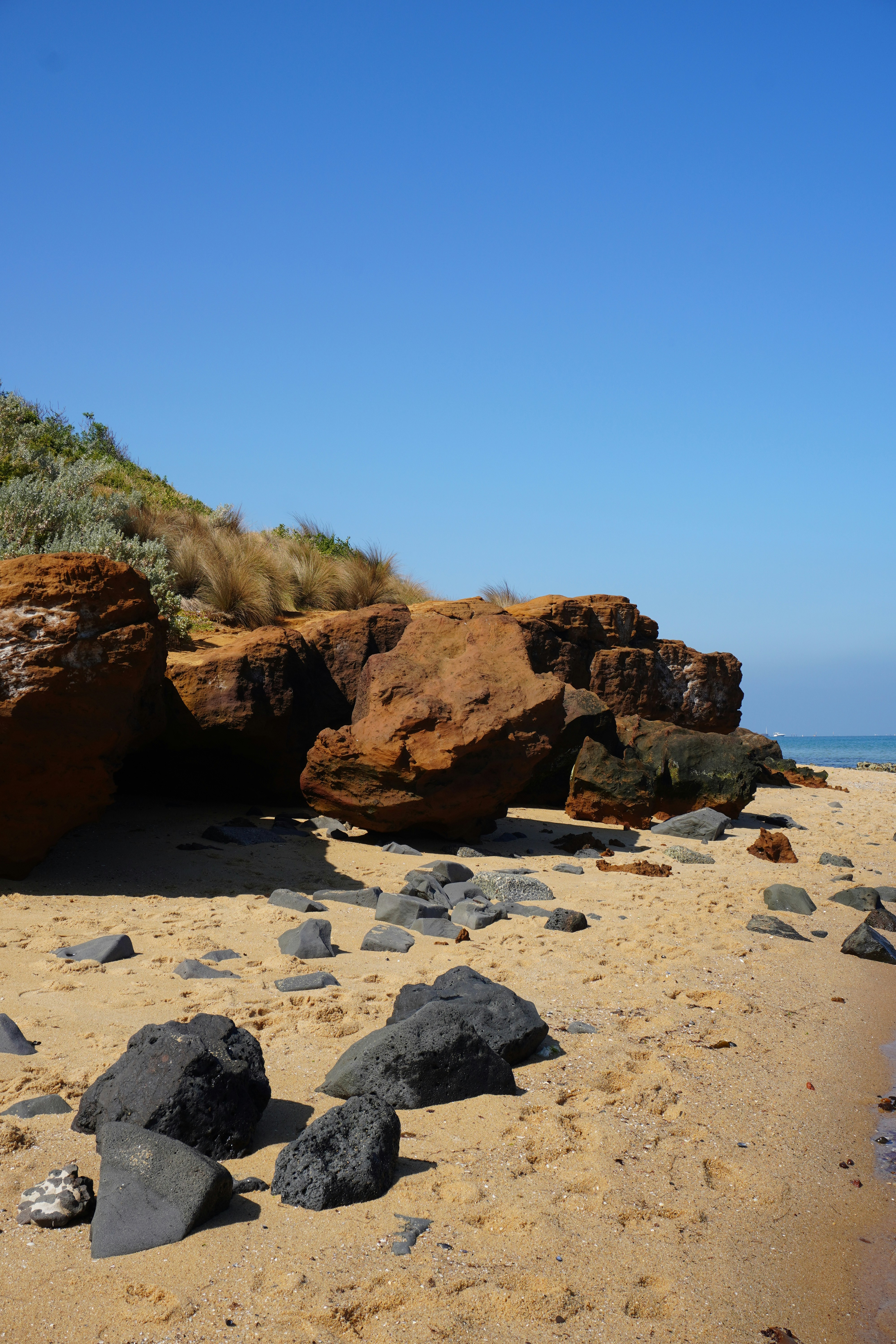 Coastal Redstone Cliff by a Quiet Blue Sea