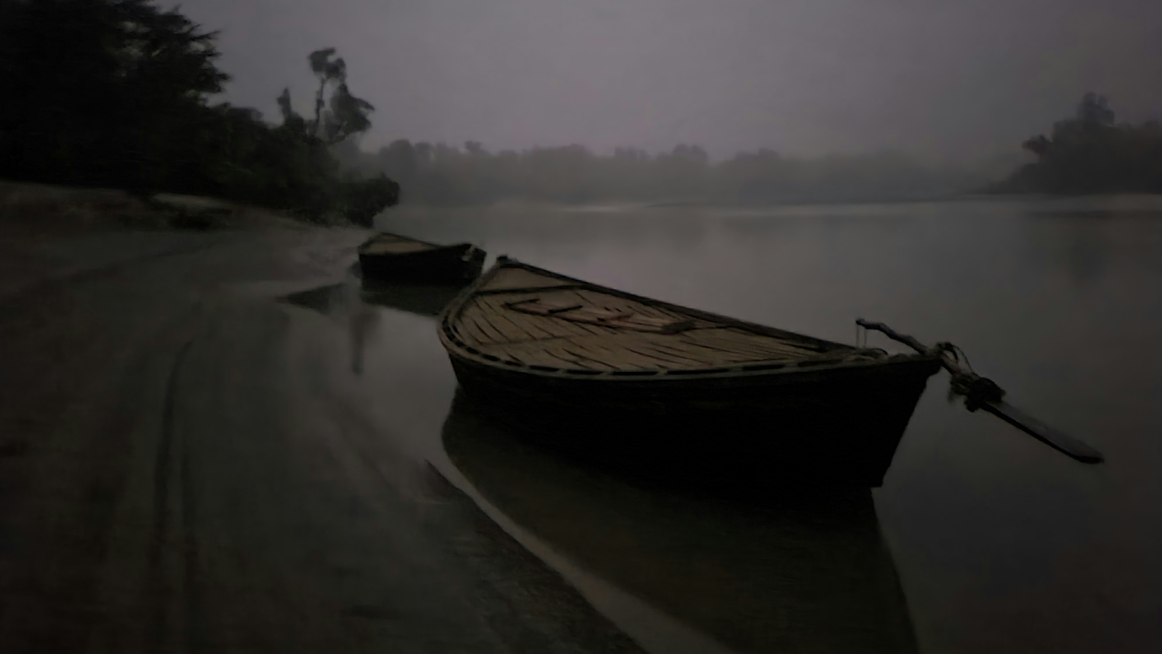 Shoreline in the Mist: A Wooden Boat Resting by a Quiet Lake