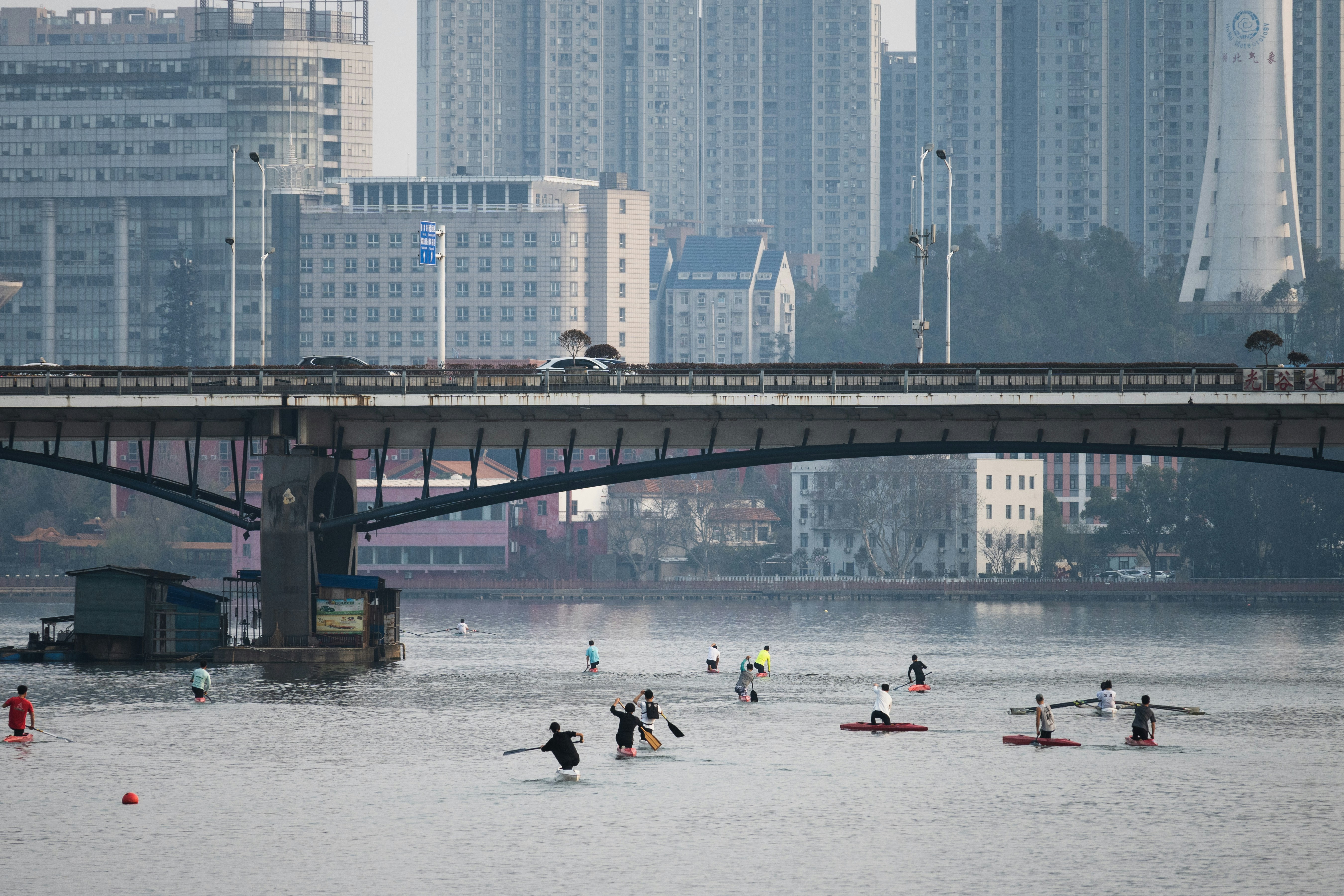 Riverbank Riders Under a City Bridge