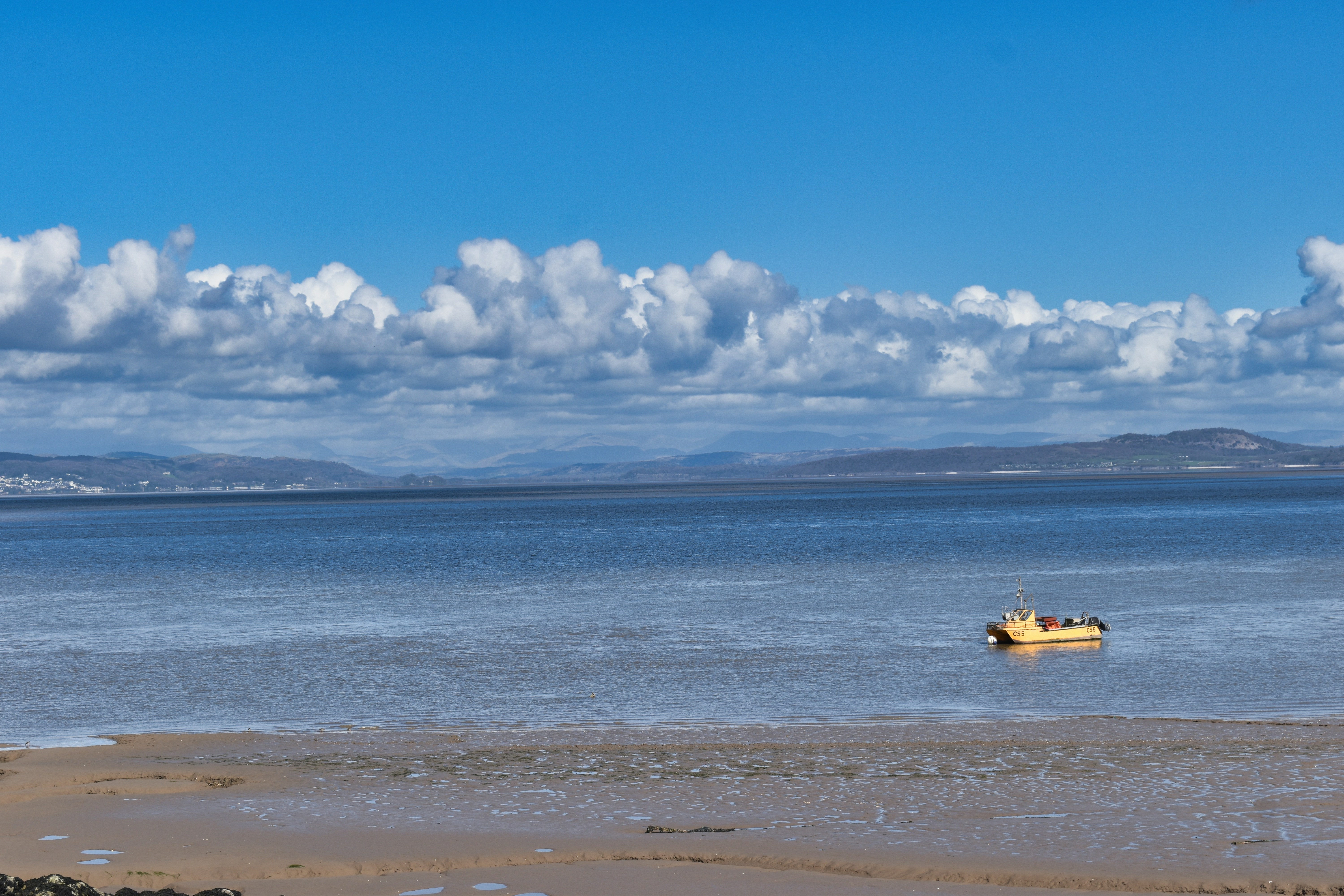 A boat floating on top of a large body of water photo – Free Morecambe ...
