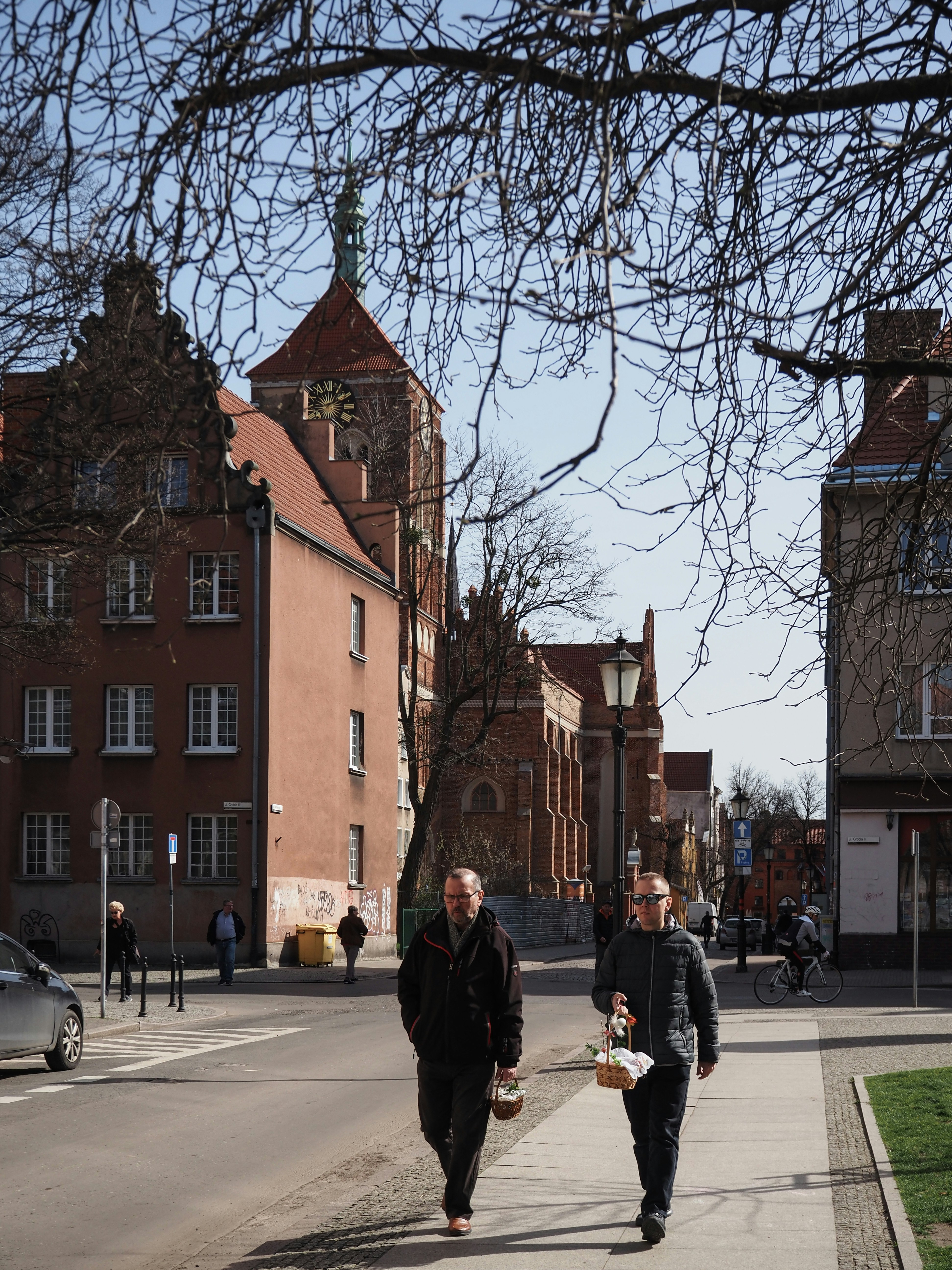 Two Basket Carriers on a Sunlit European Street