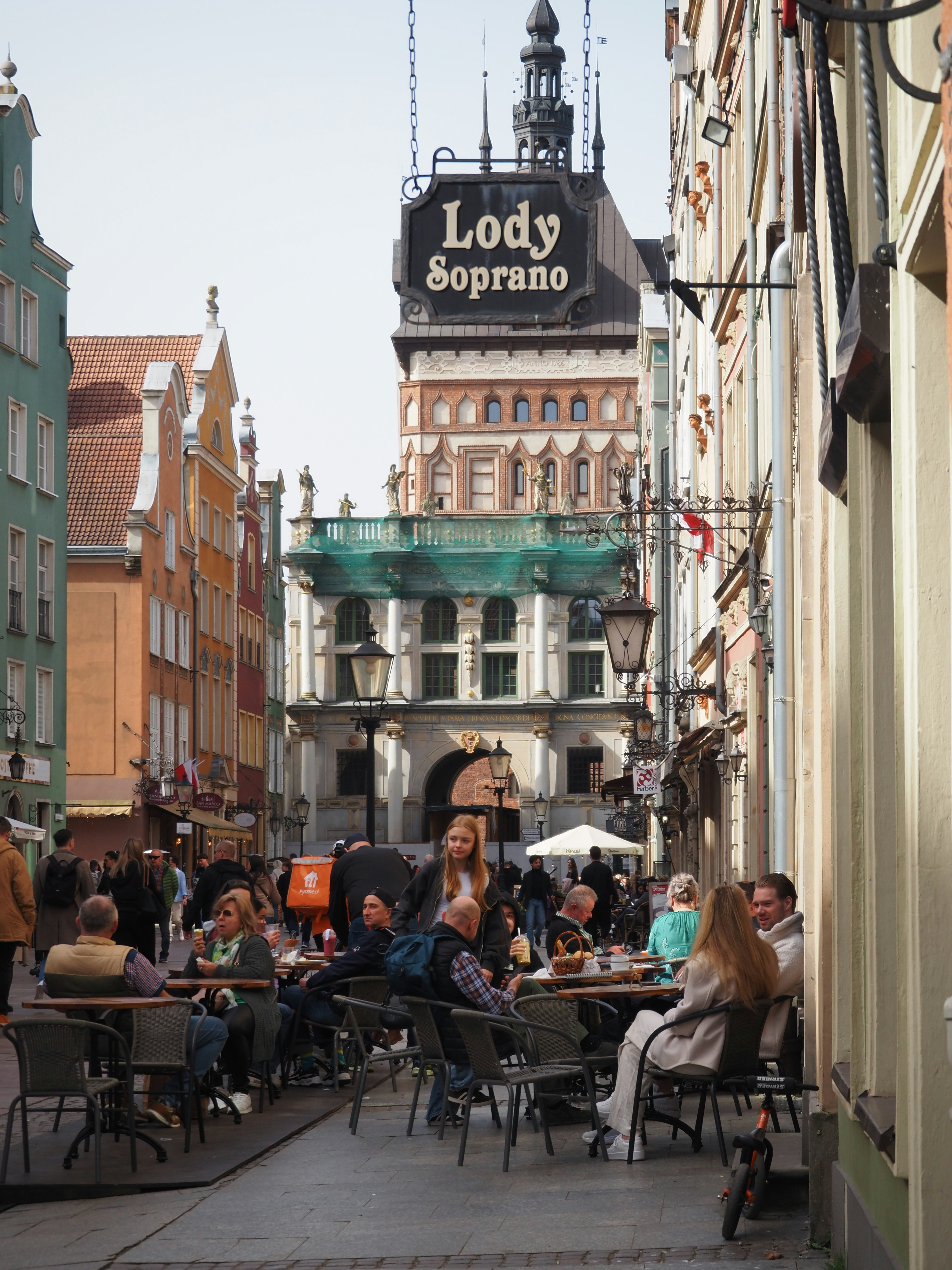 Lody Soprano Arc: A Sunlit Café Scene Framed by a Vintage Sign