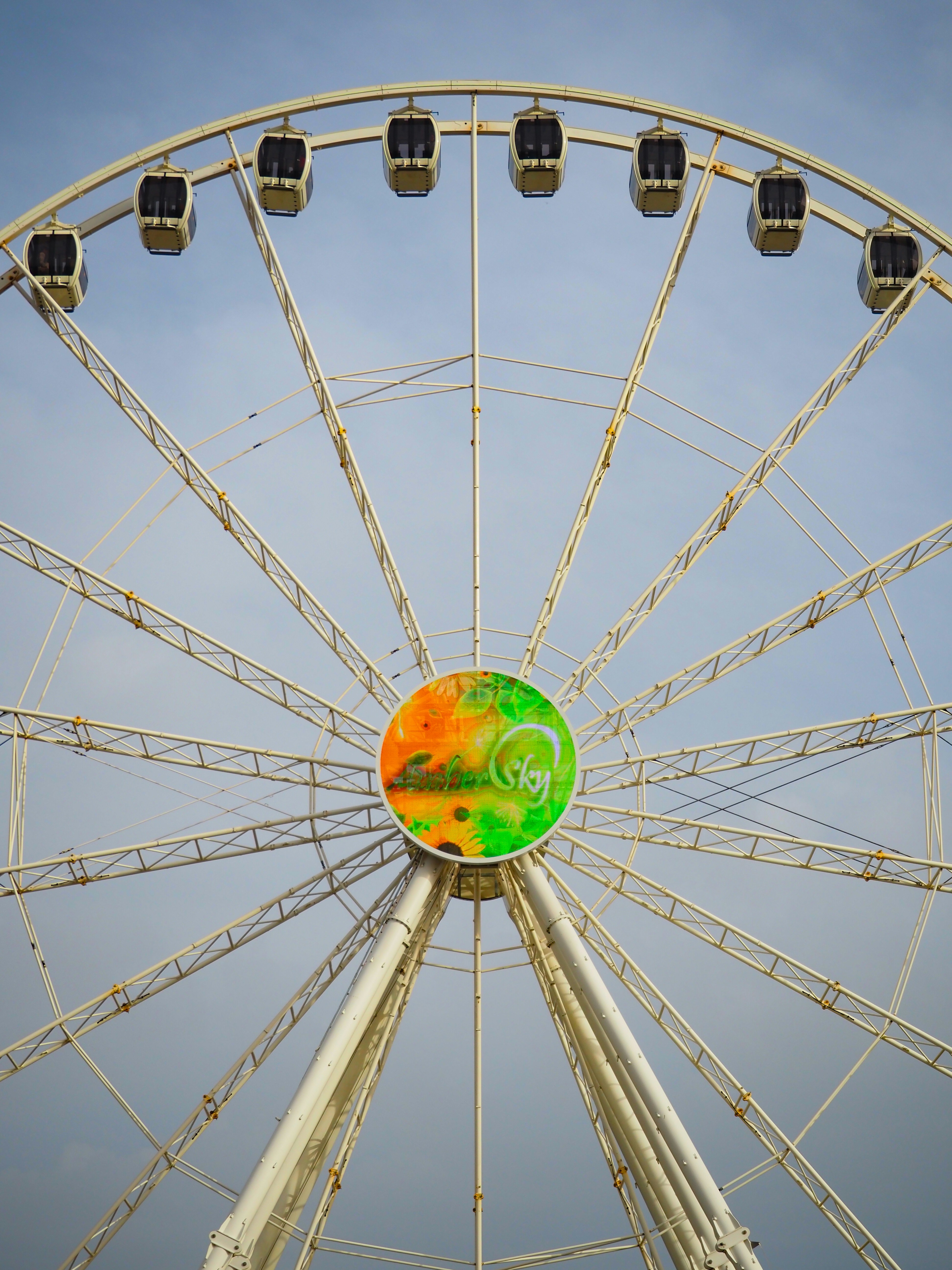 A ferris wheel with a green and orange sign on it photo – Free Gdańsk ...