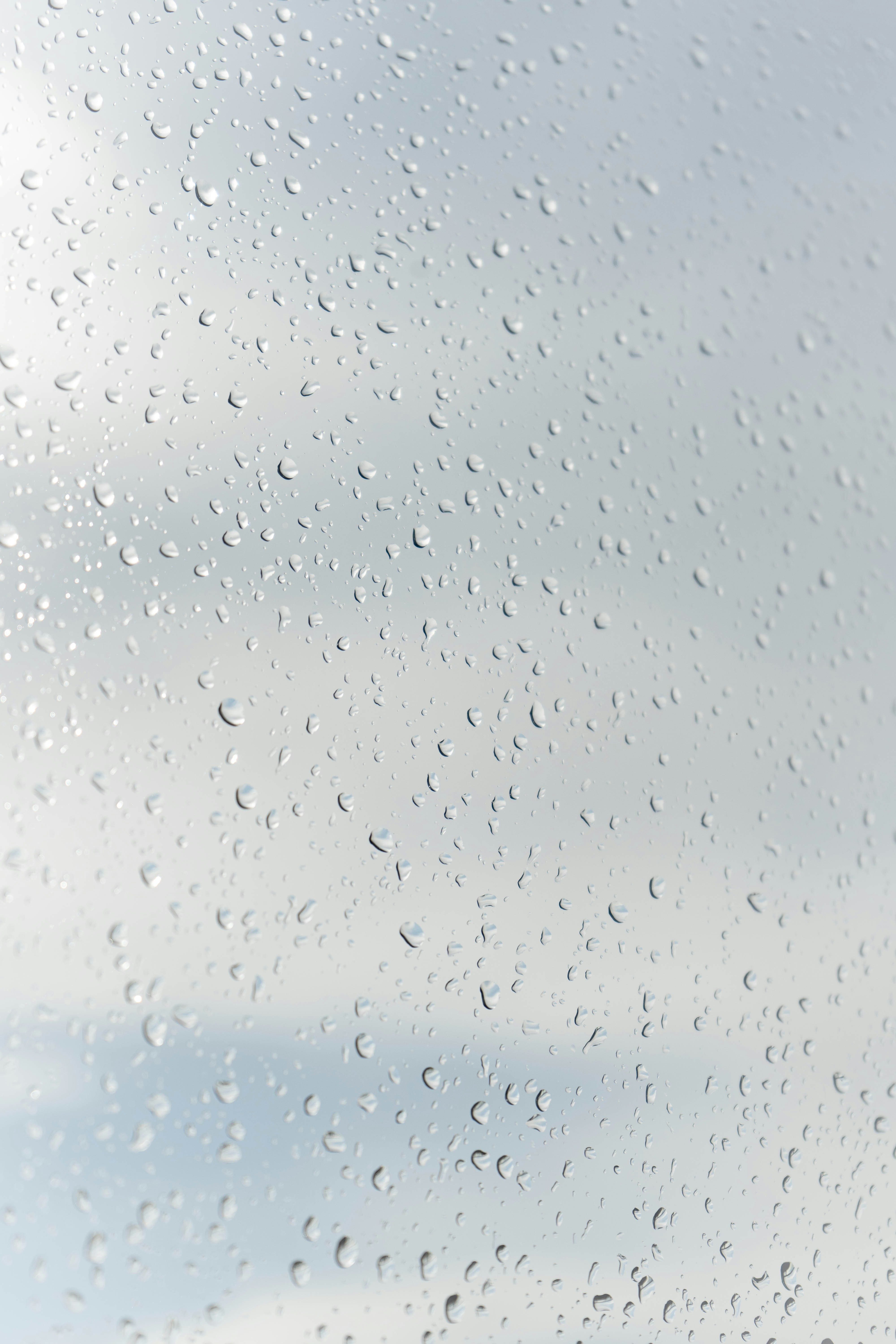 Rain drops on a window with a sky in the background photo – Free Grey ...