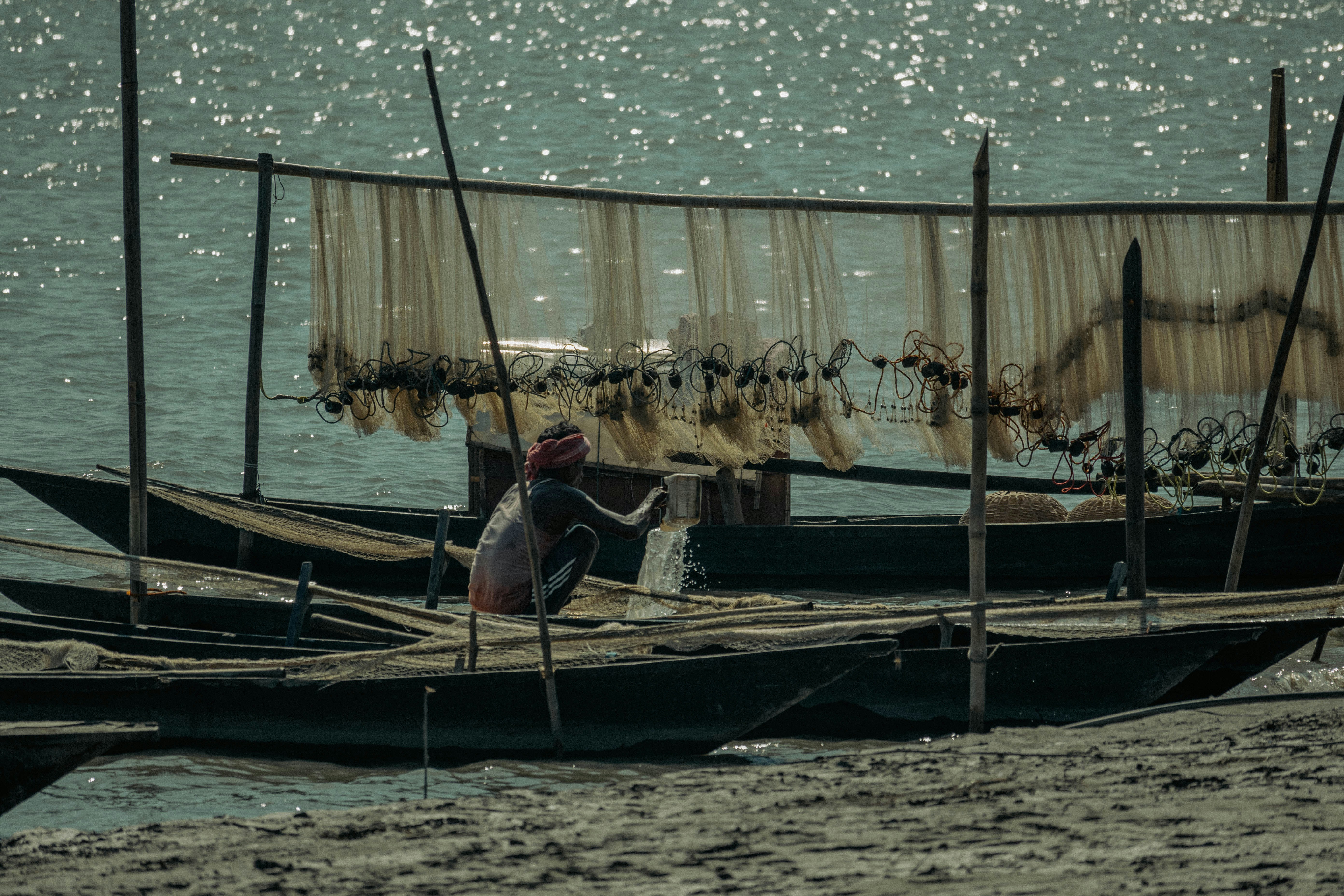 Harbor Solitude: A Fisherman Resting Among Drying Nets