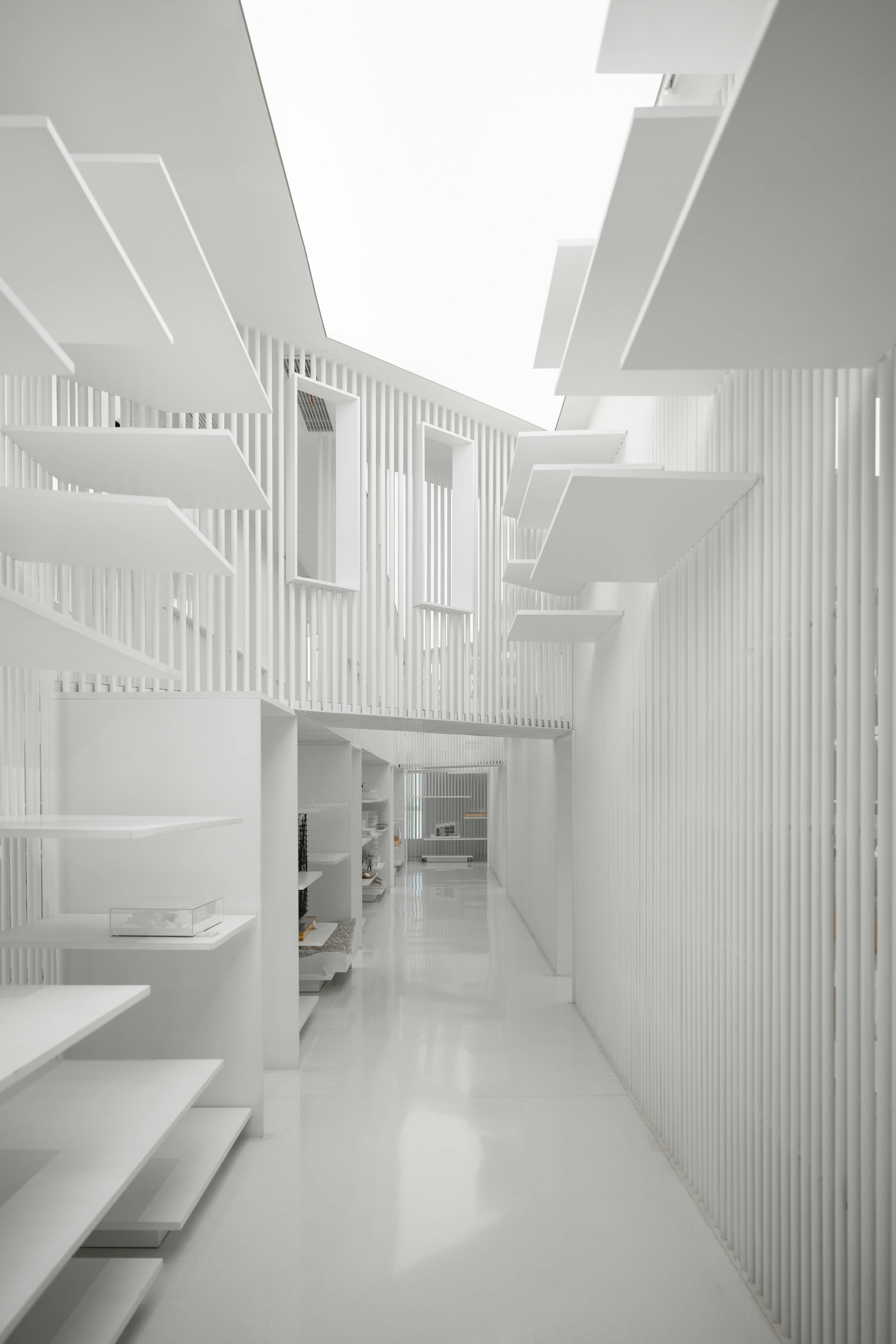 White interior partition walls and shelves, with corridors and windows on the second floor
