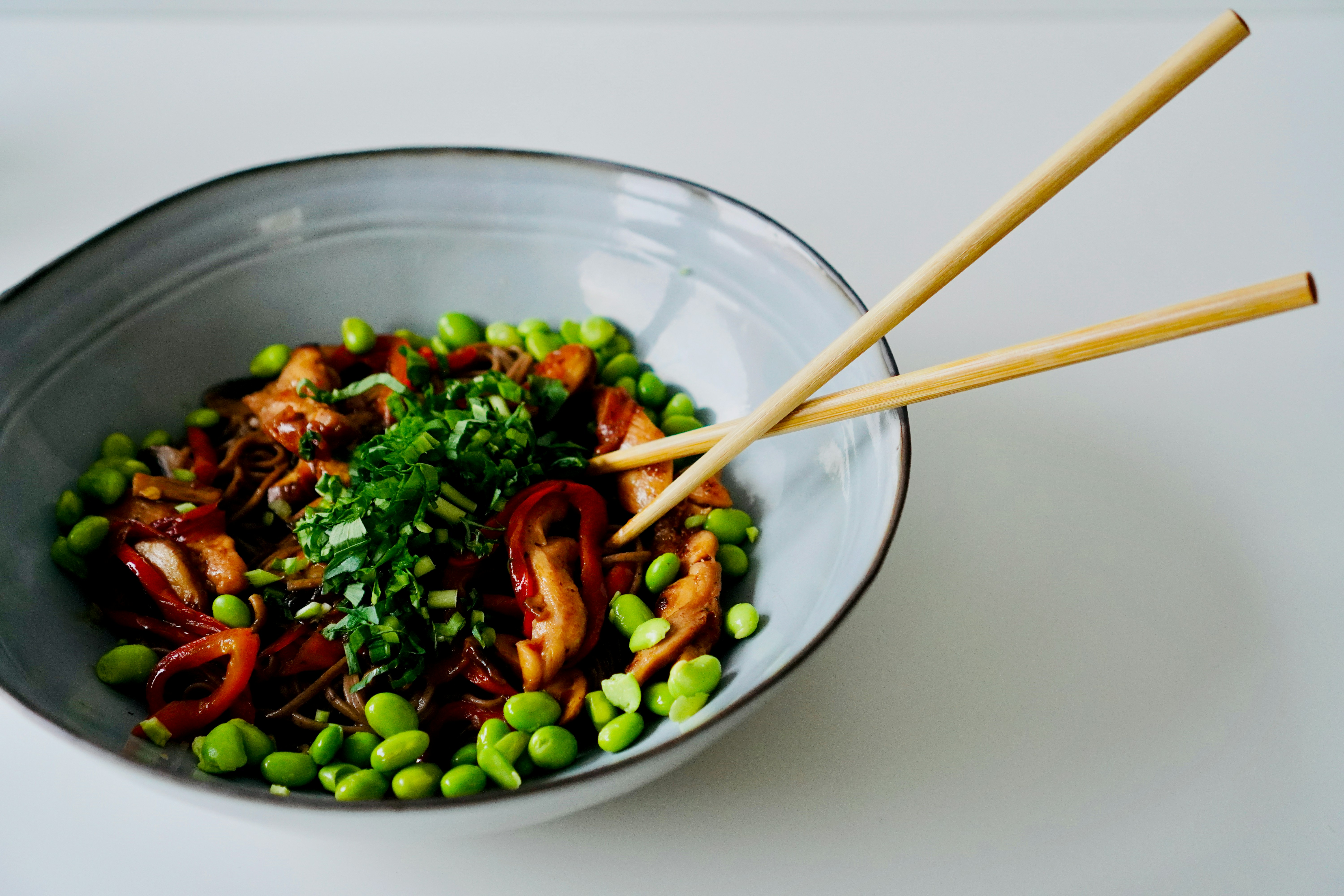 Chopstick Arc Over a Emerald Edamame Bowl: A Minimalist Food Portrait