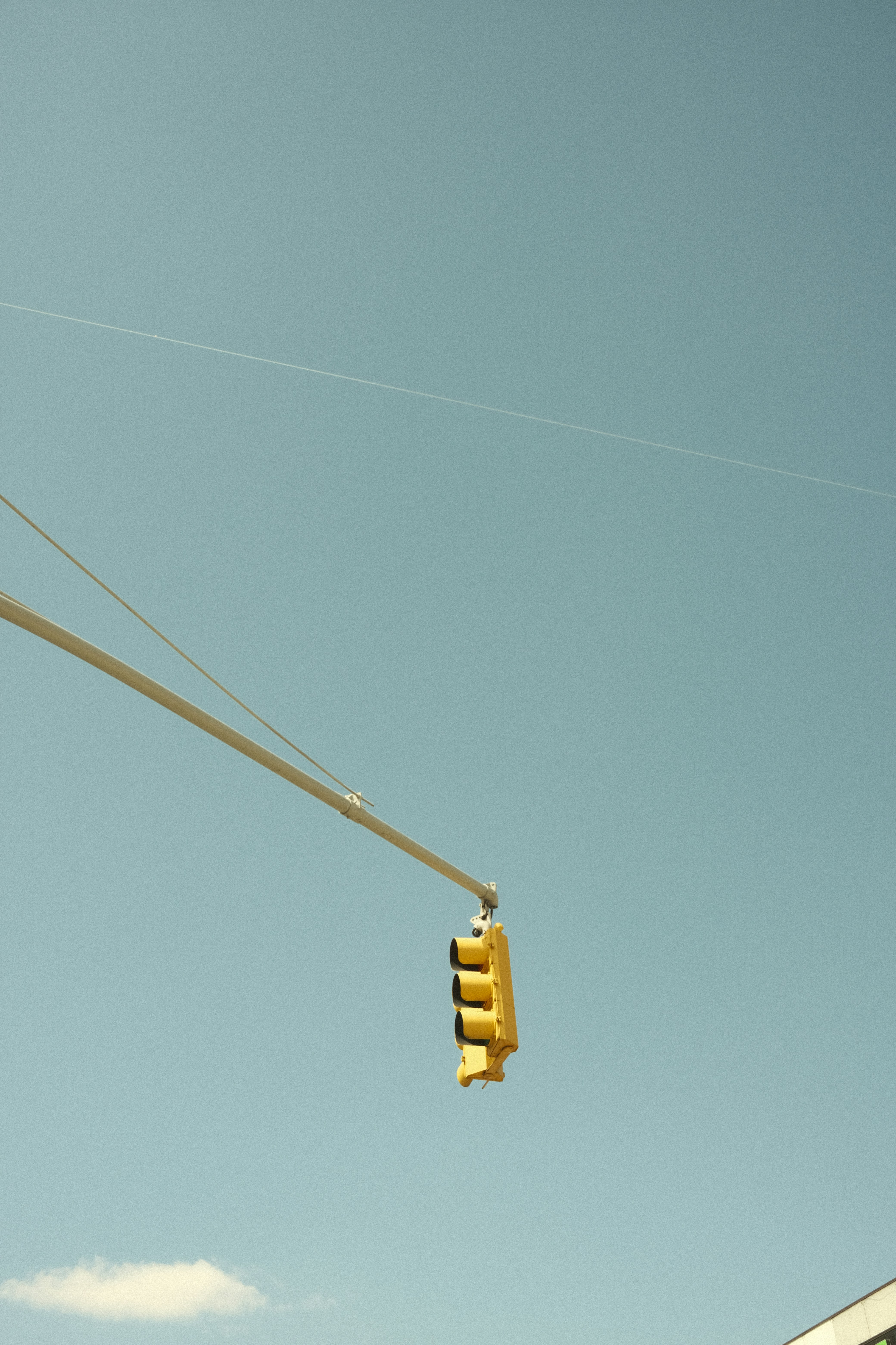A yellow traffic light hanging from a wire photo – Free Green Image on ...