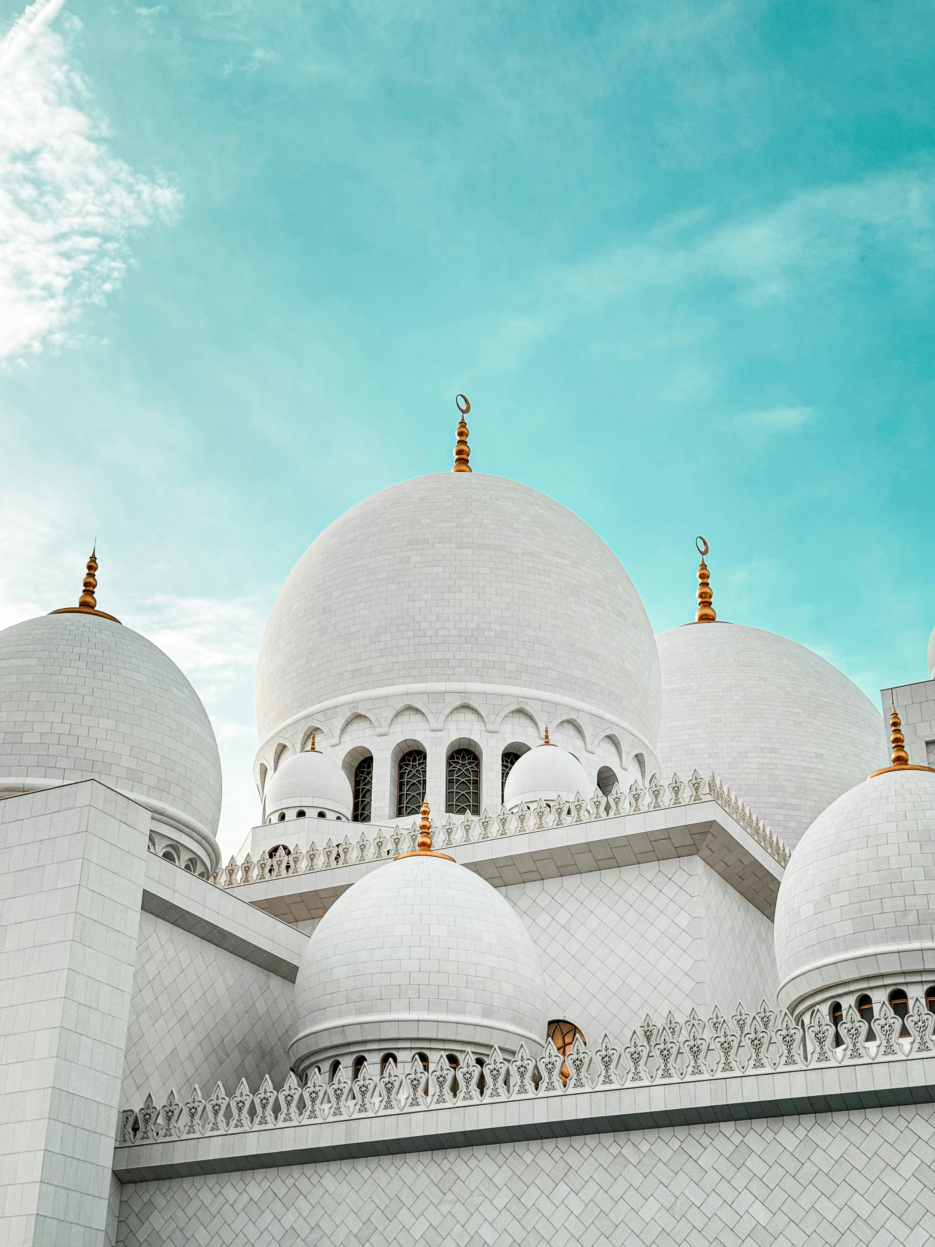Domes of Serenity: White Minarets Against a Turquoise Sky