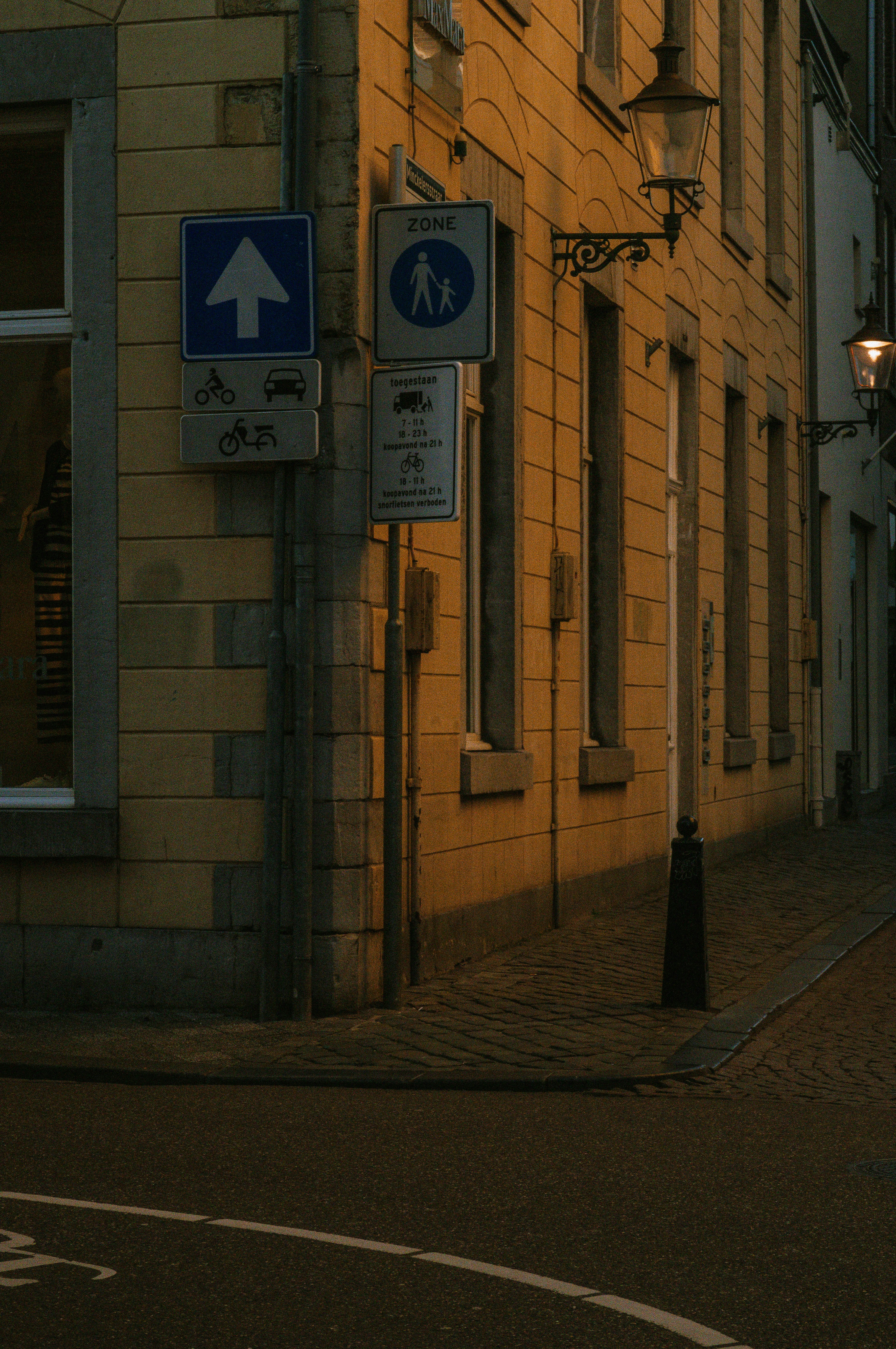 Amber Hour on a Signpost Street: Weathered Facades and Quiet Signage