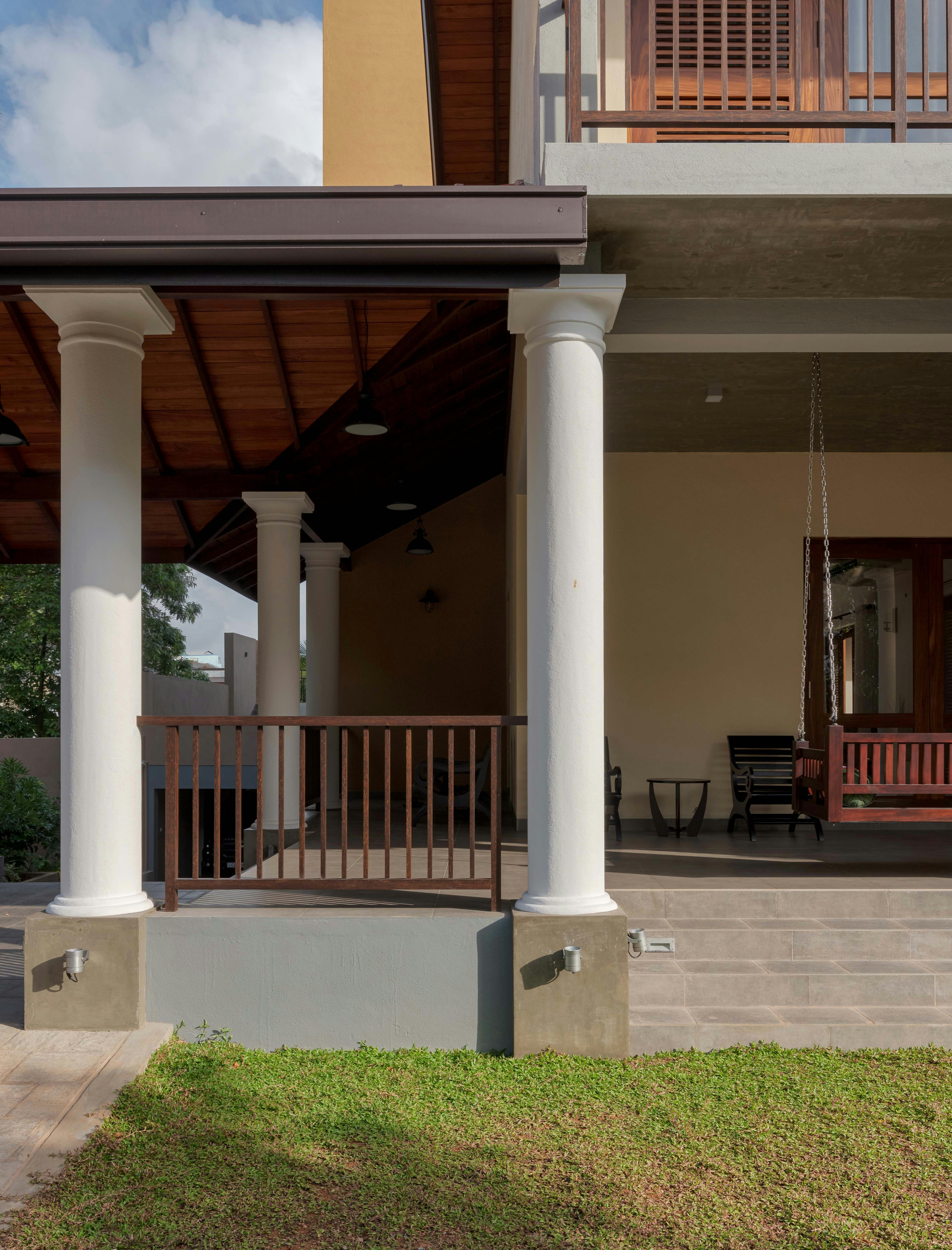 A porch with columns and a wooden railing photo – Free Courtyard Image ...