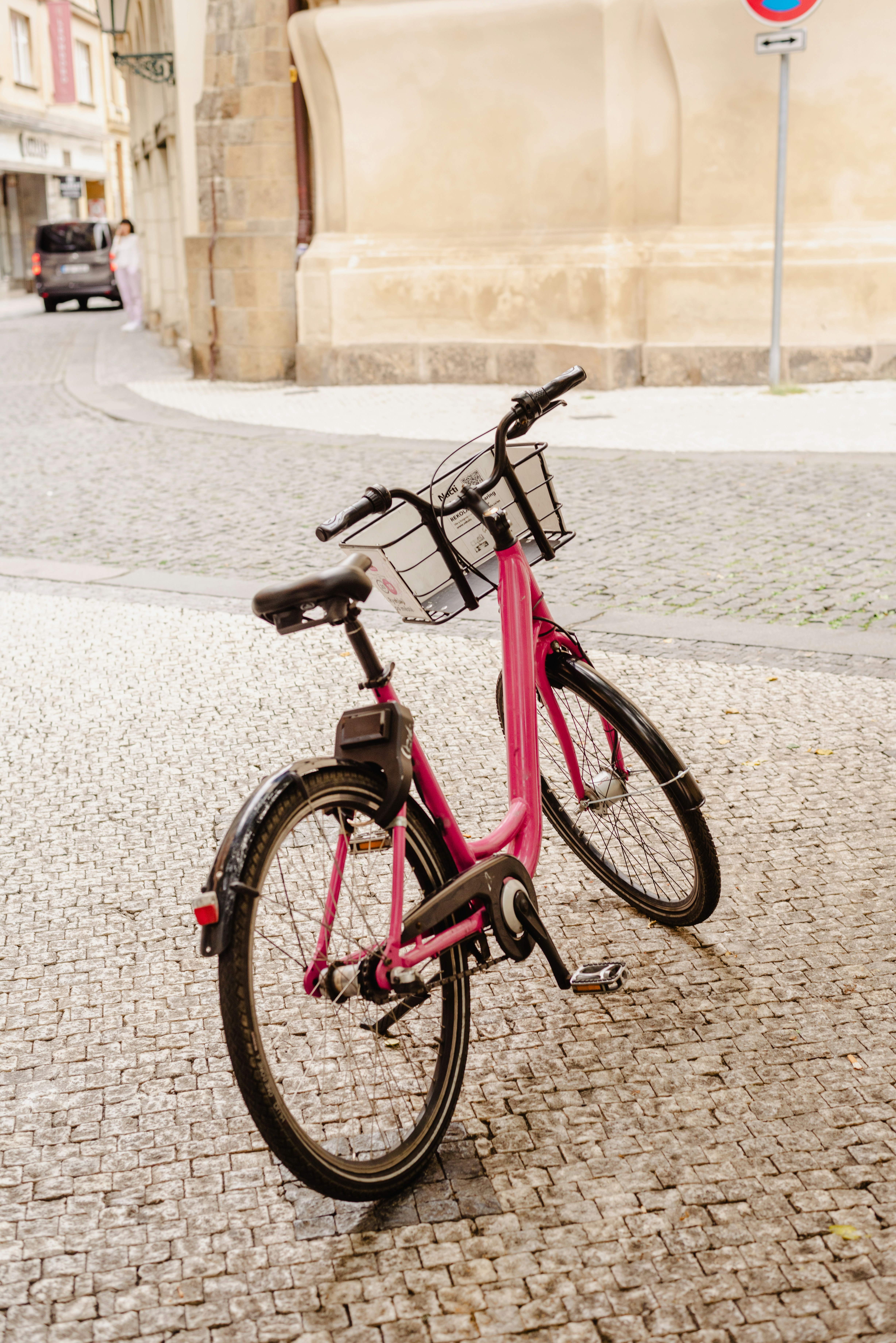 Pink Urban Bicycle Anchors a Quiet European Cobblestone Square