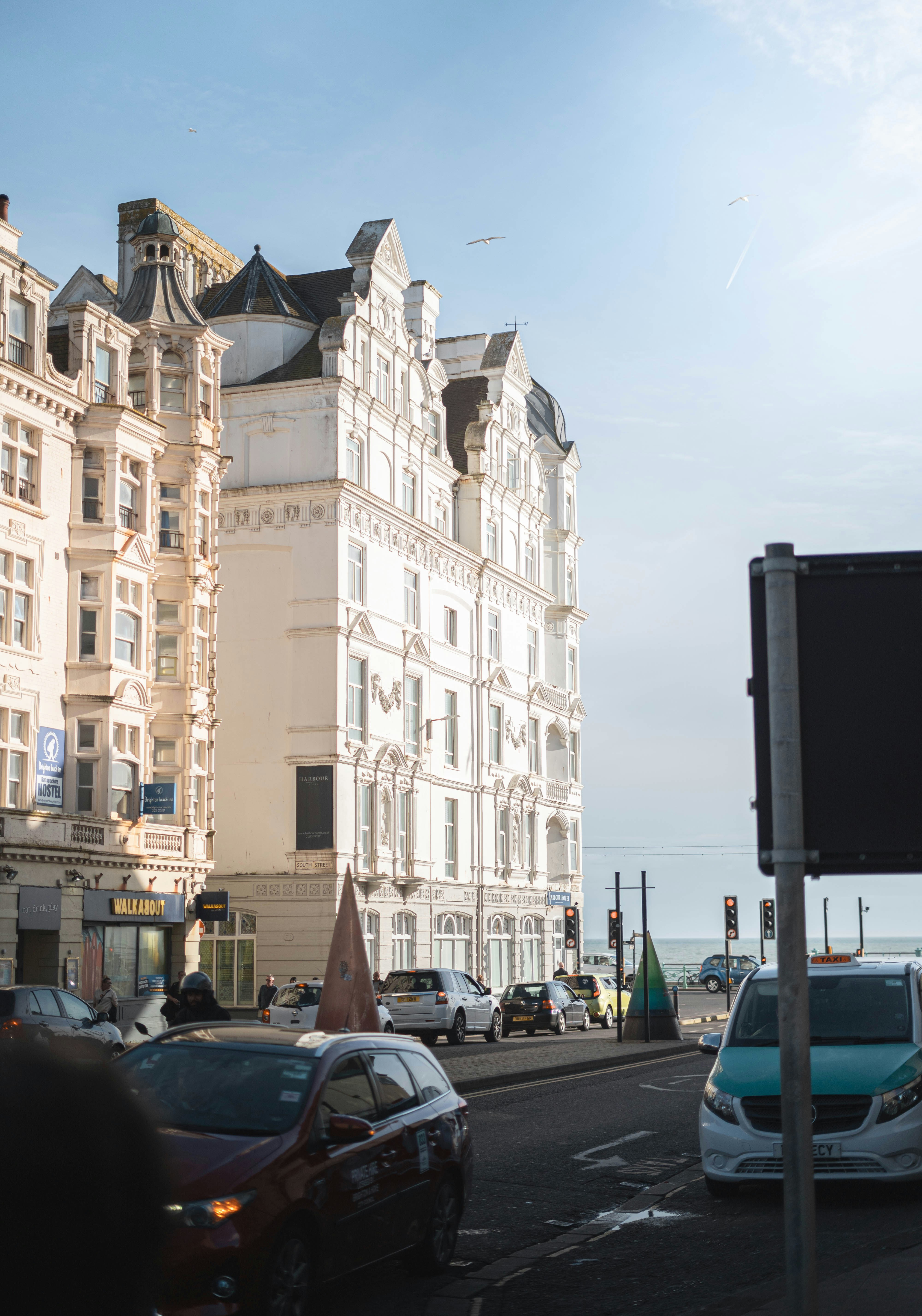 Sunlit Seaside Row: A Coastal Street in Soft Morning Light