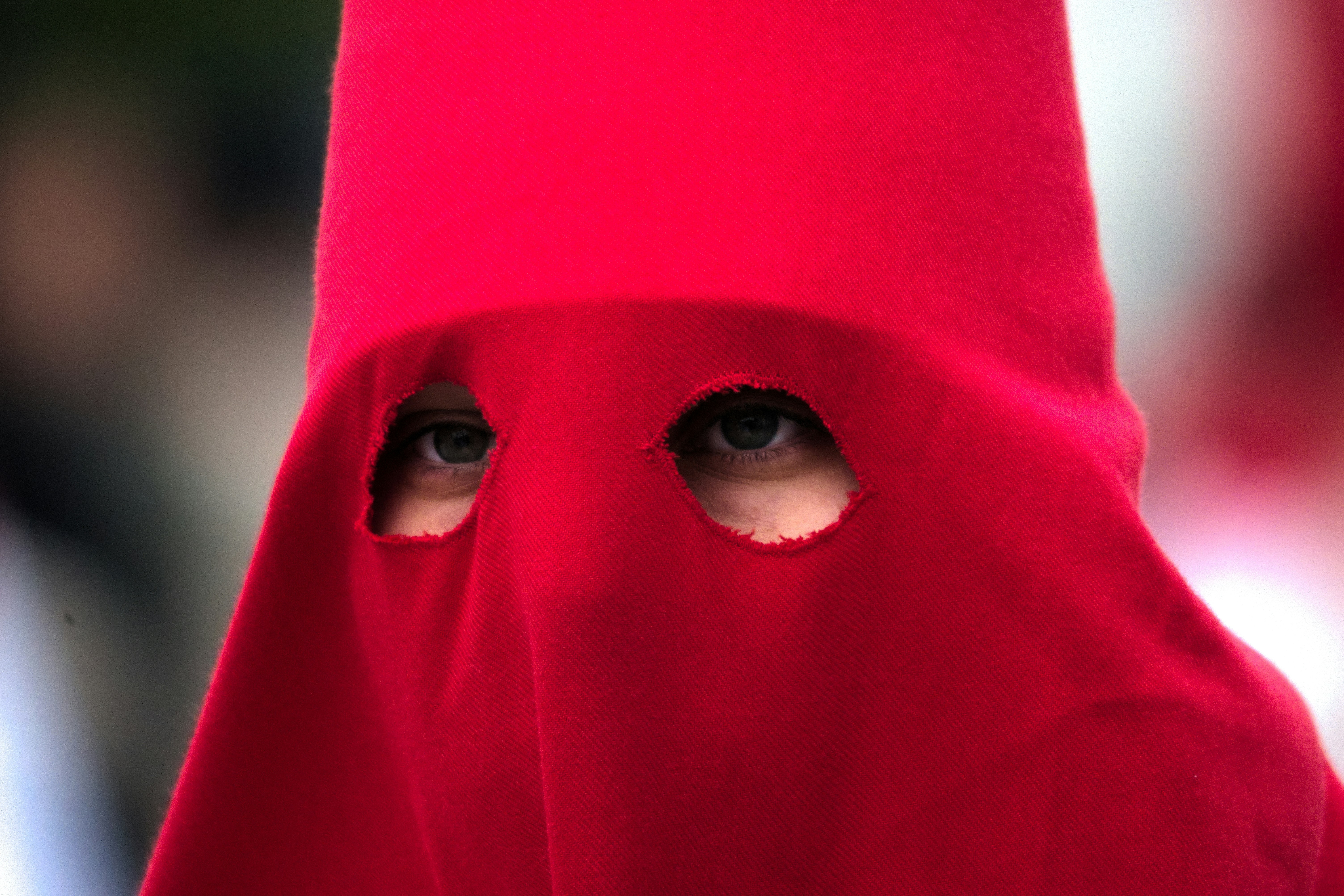 A person wearing a red burka with holes in it photo – Free Human Image ...