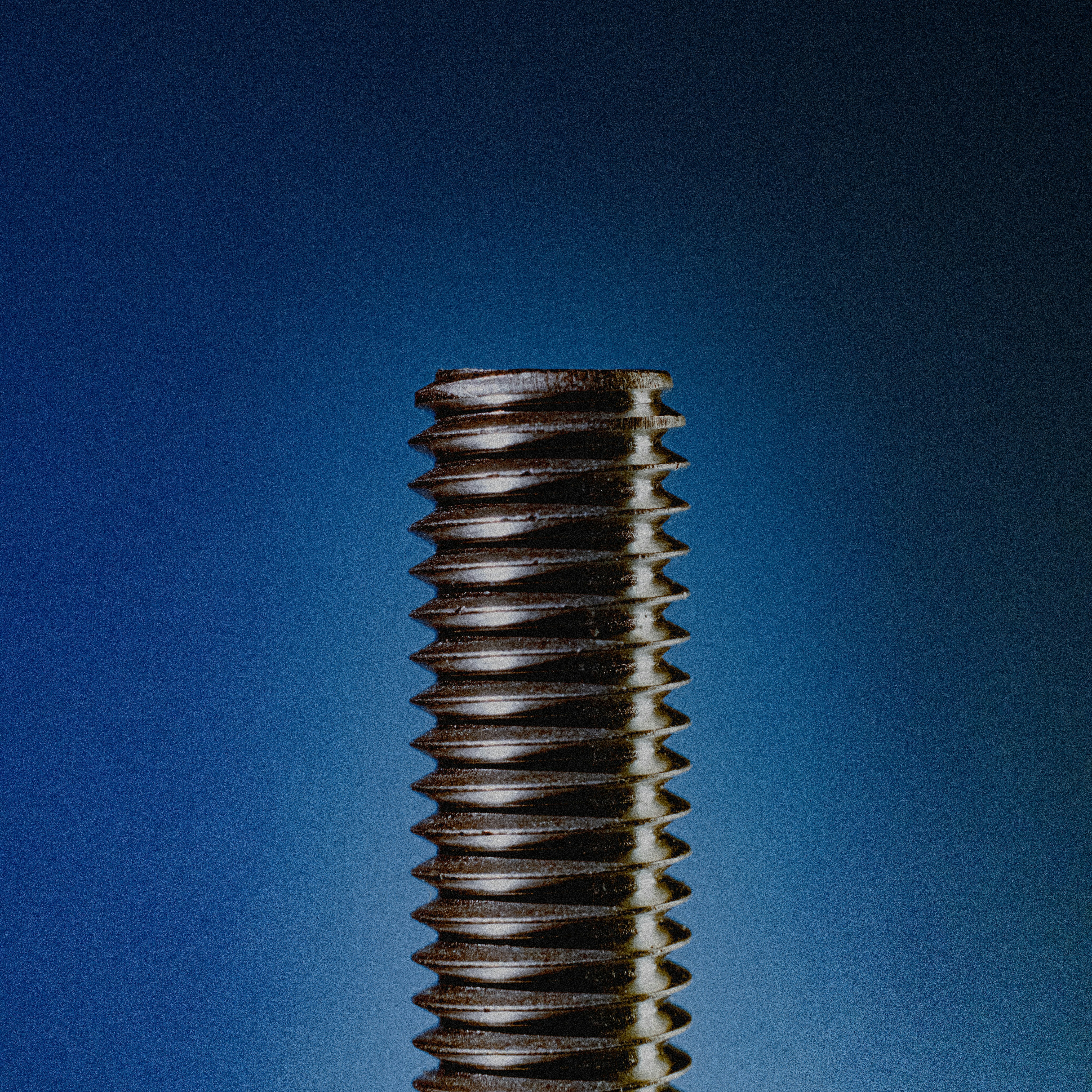 A close up of a screw on a blue background photo – Free Screw Image on ...