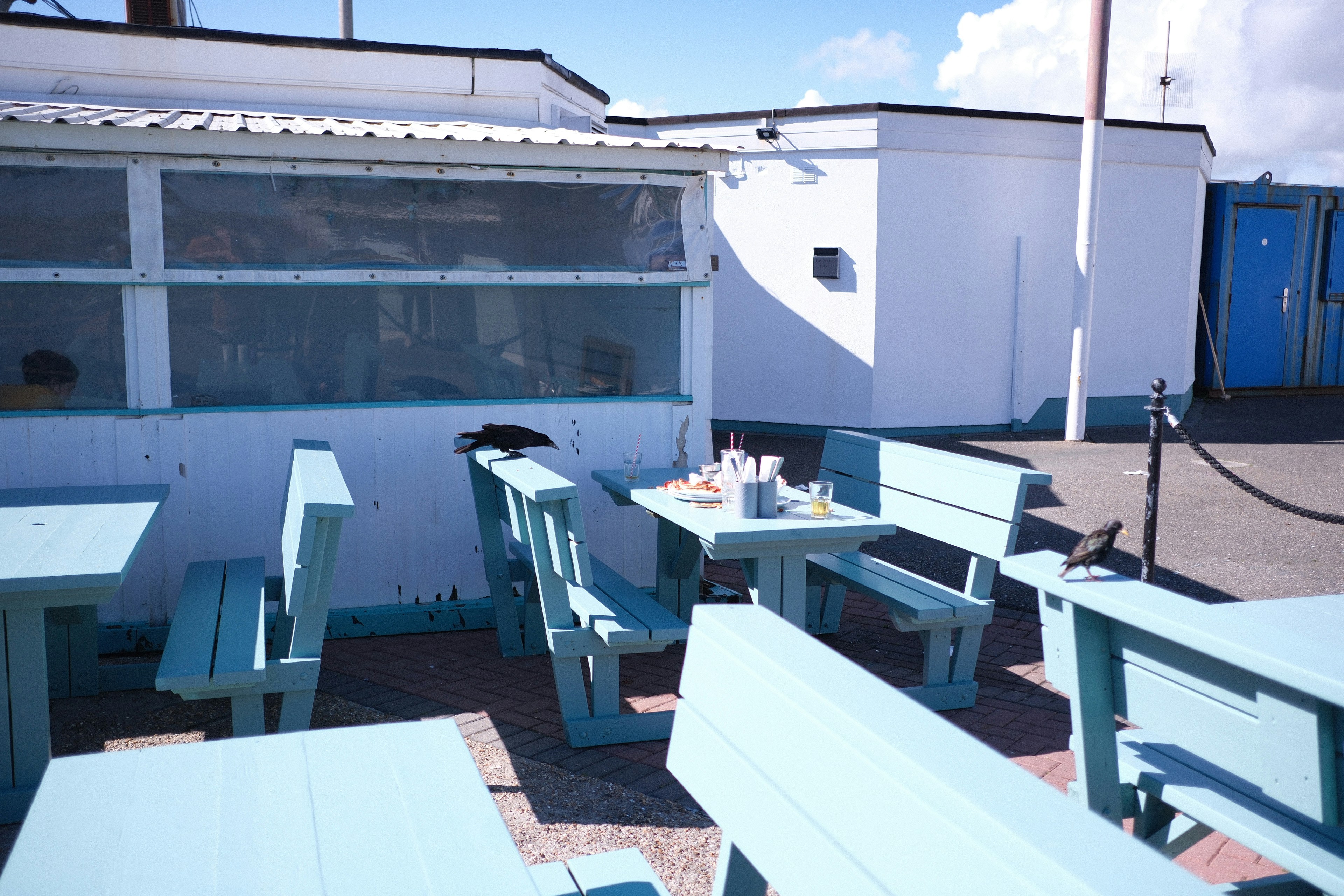 A group of benches sitting outside of a building photo – Free Human ...