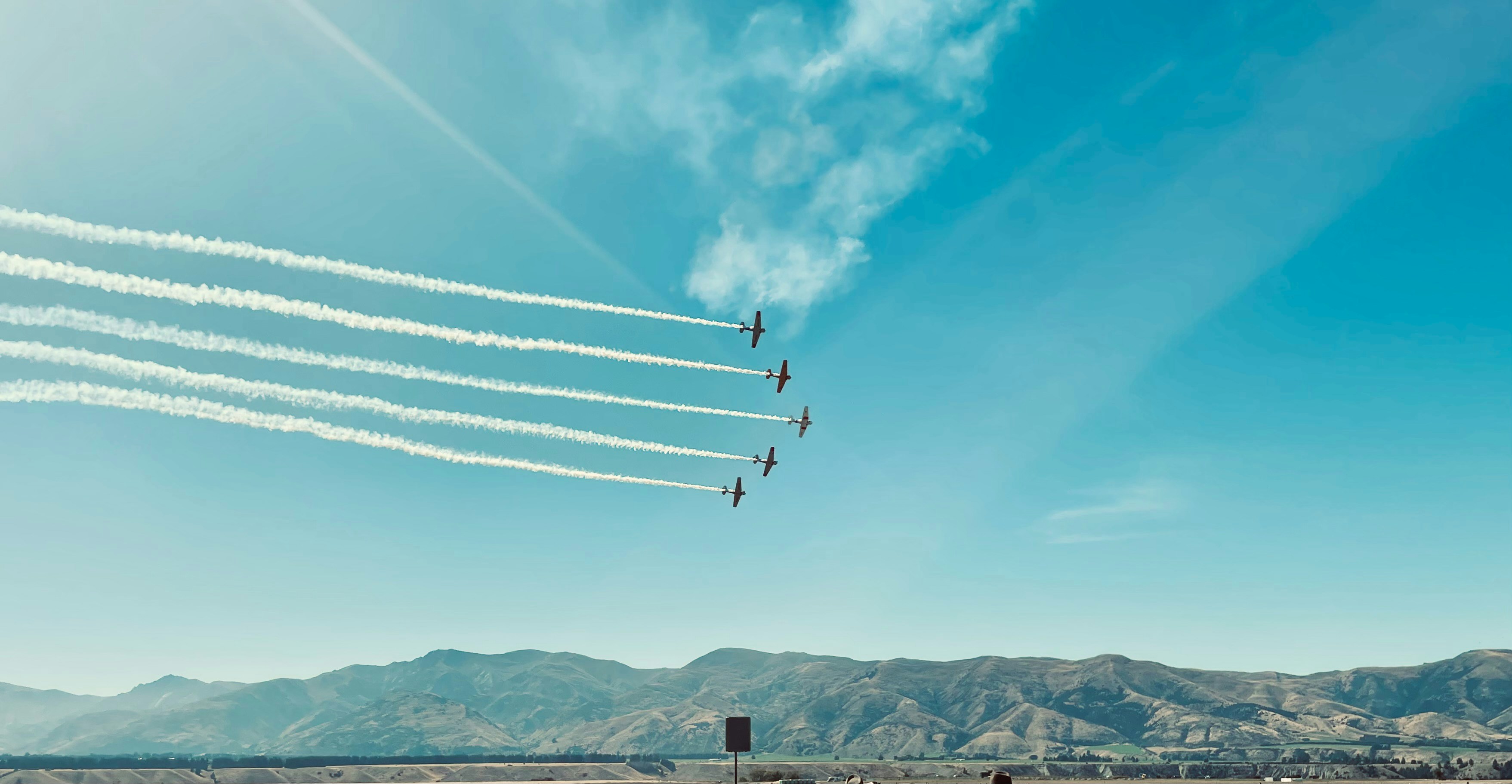 Six Contrails Across a Desert Sky