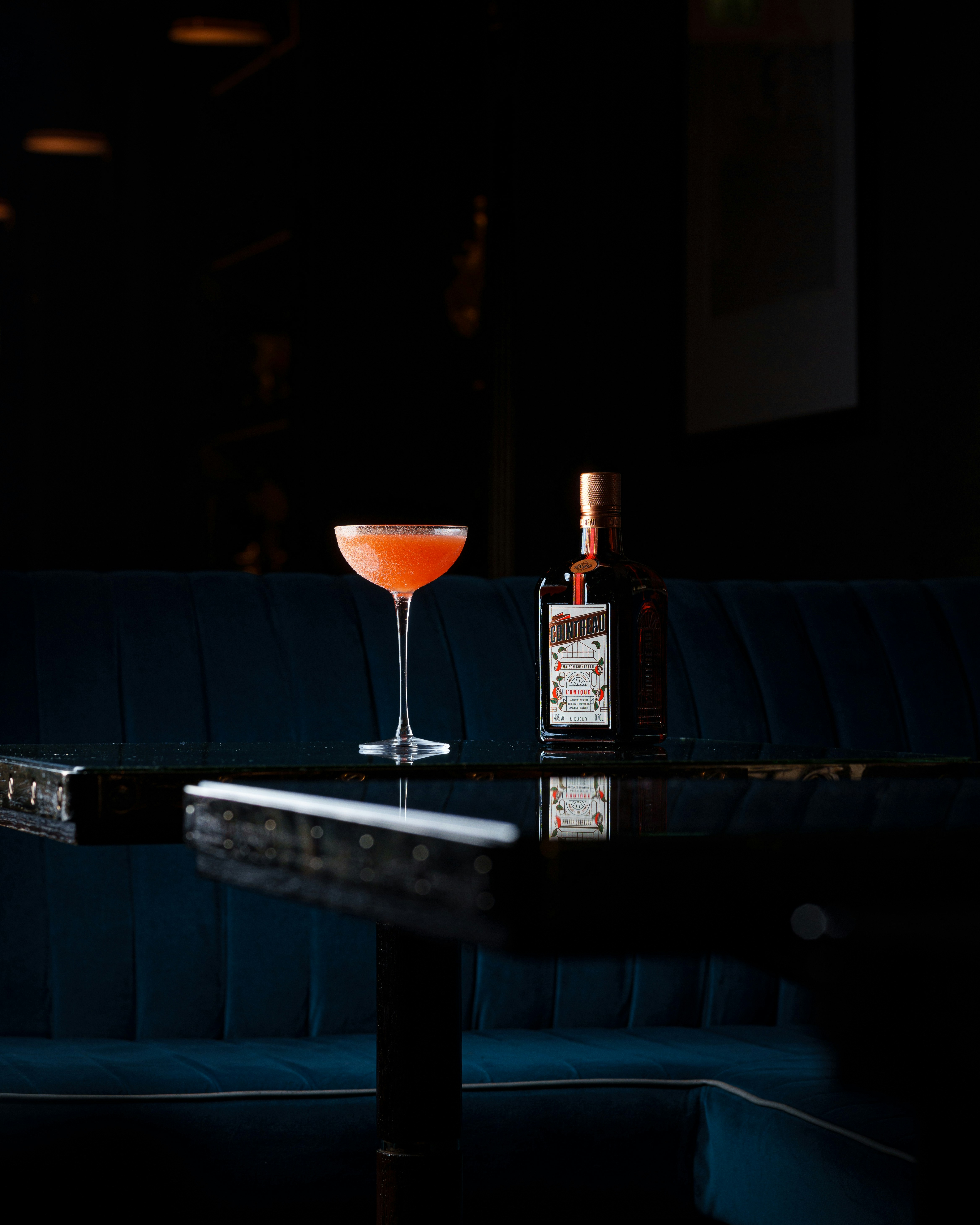 A table with a bottle of alcohol and a glass on it photo – Free Glass ...