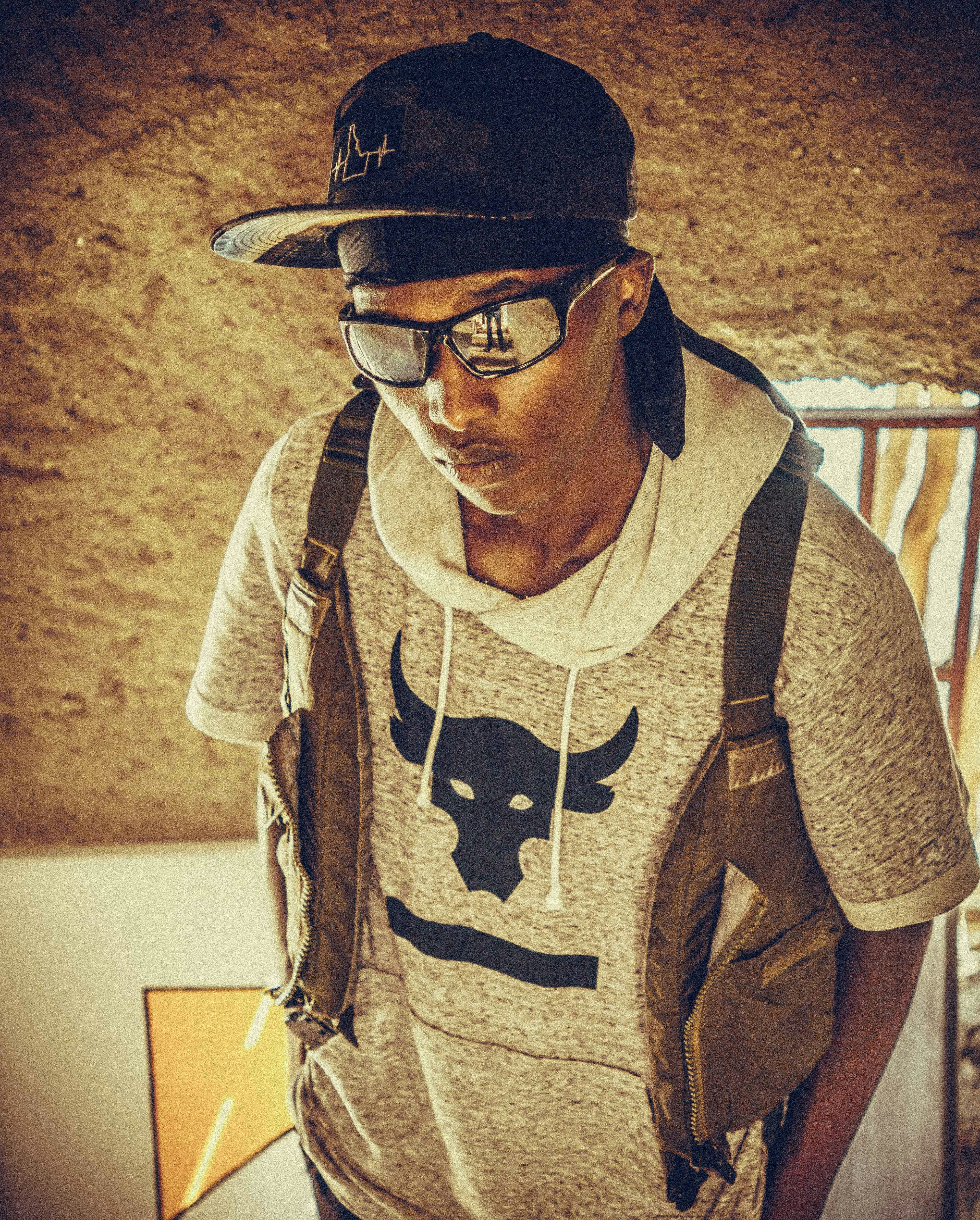 a young man wearing a hat and glasses