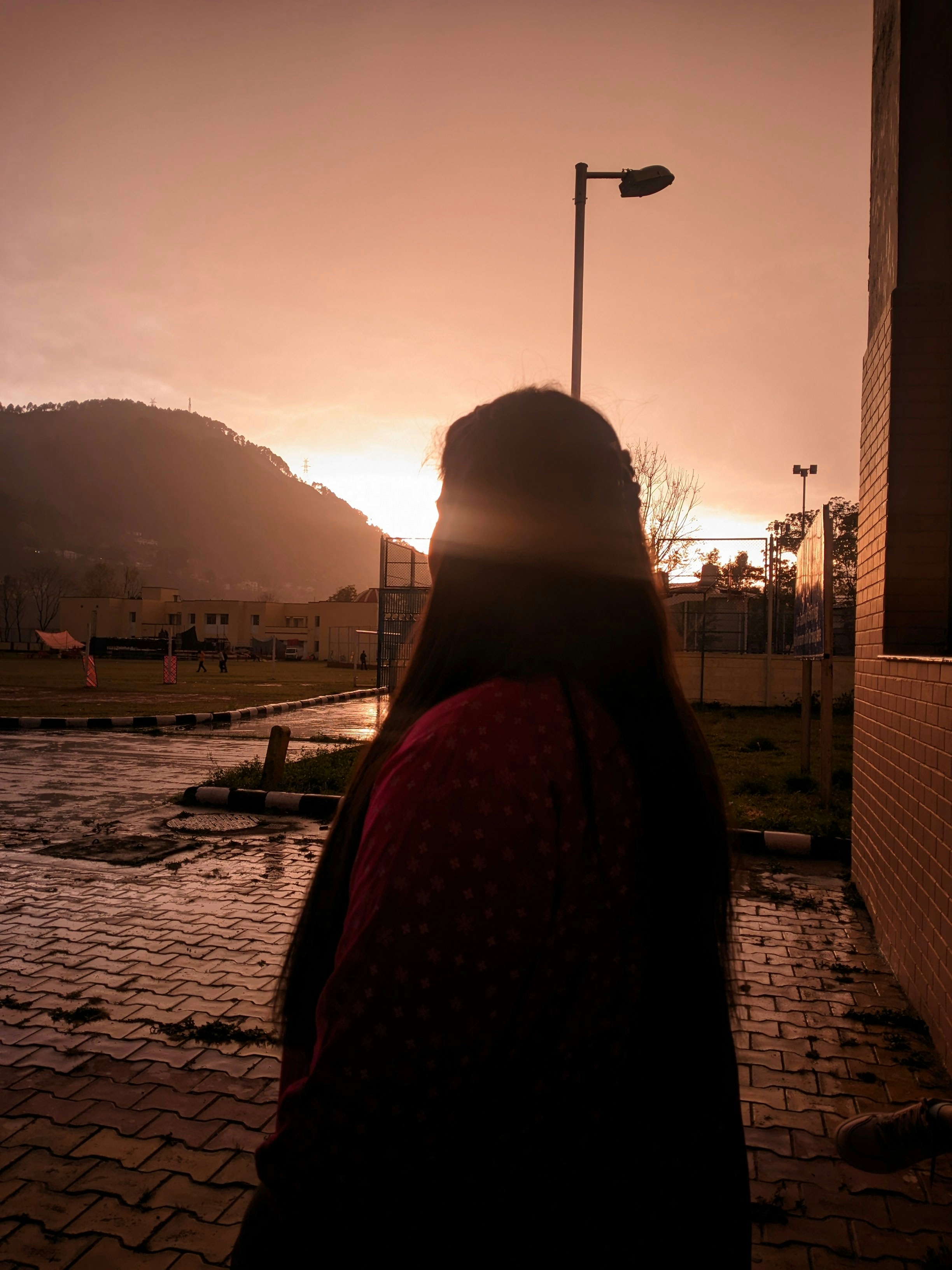 Sunset Silhouette: A Quiet Portrait in Warm Streetlight Glow
