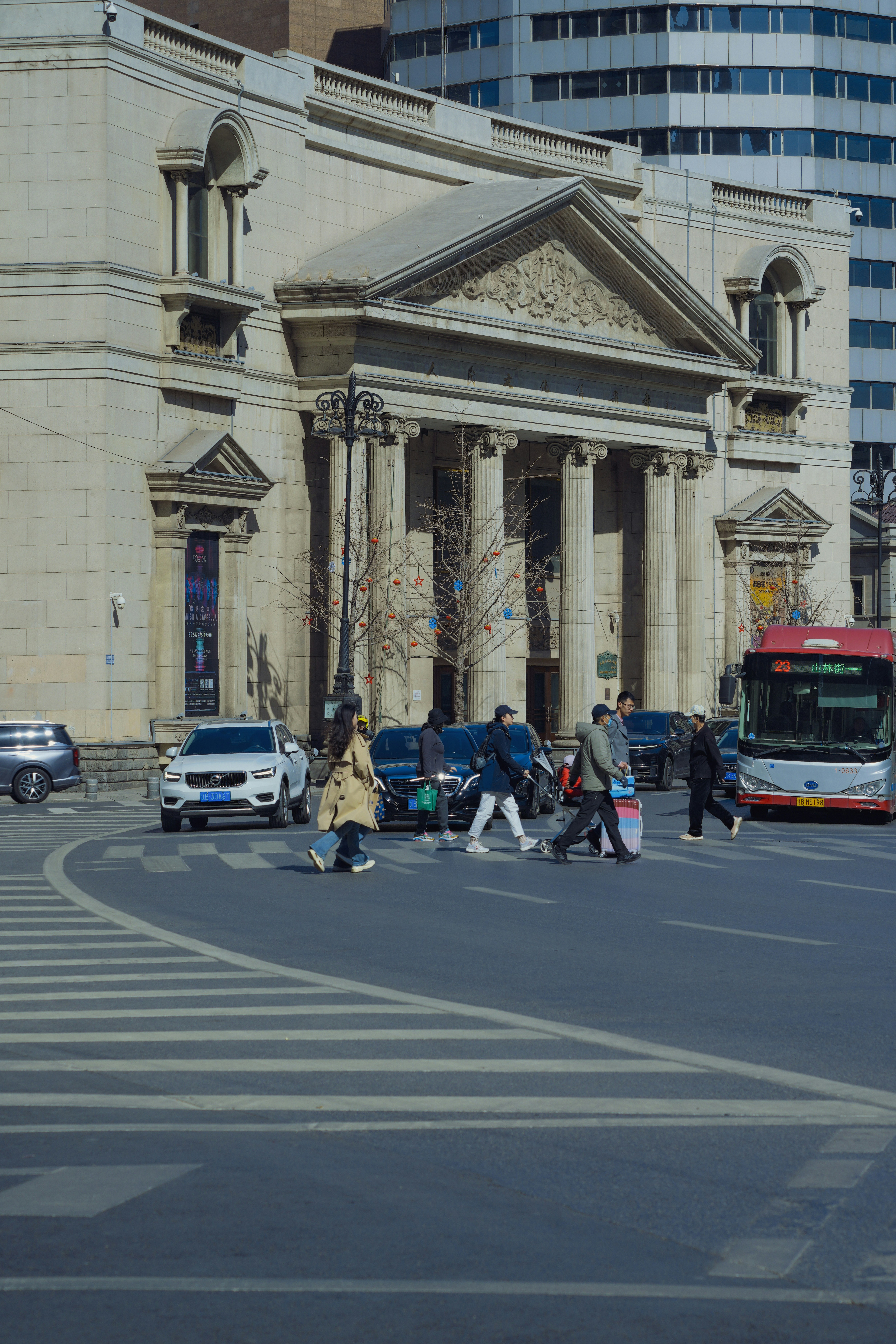 Crosswalk Convergence: Pedestrians Beneath a Neoclassical Facade