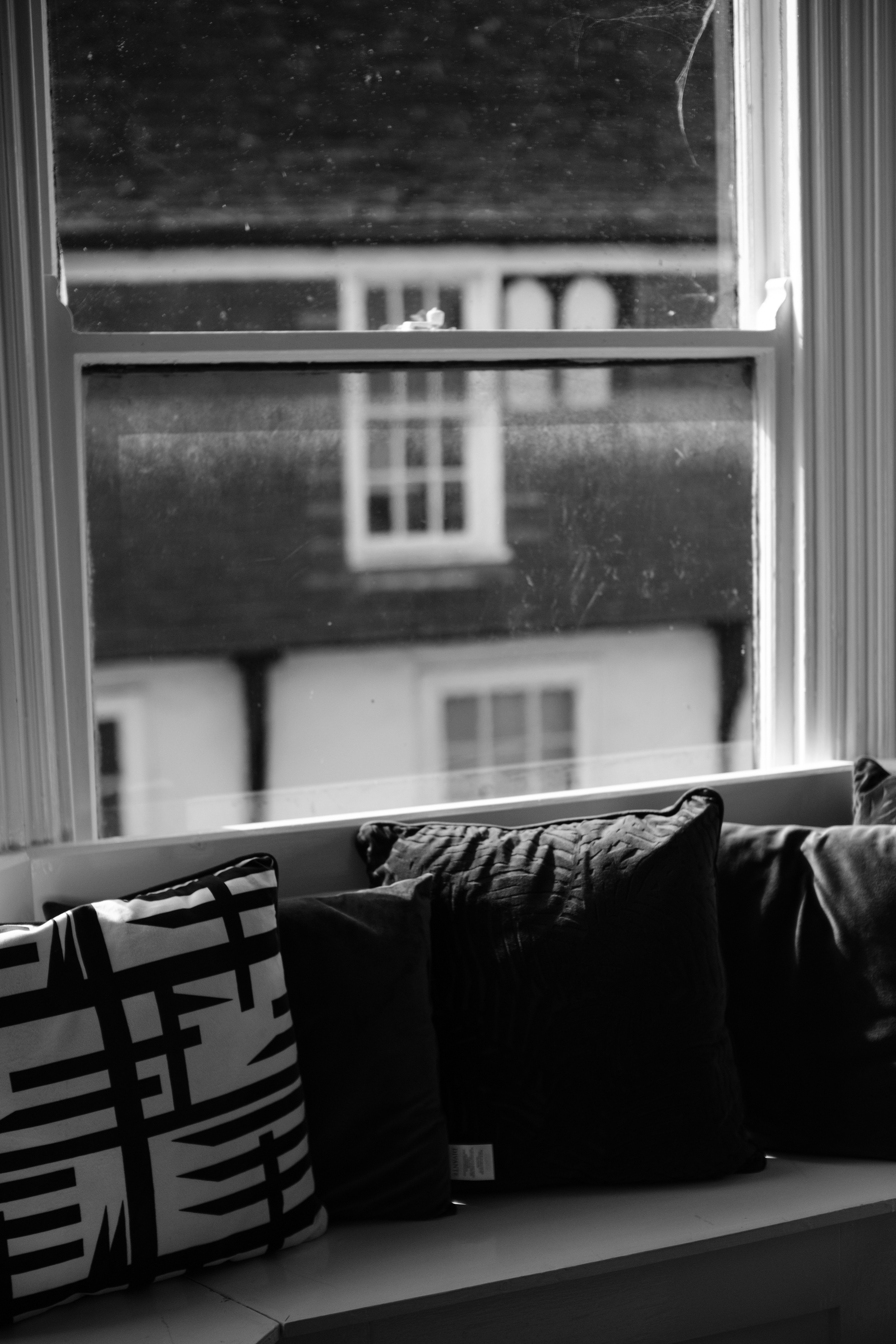 a black and white photo of a window sill