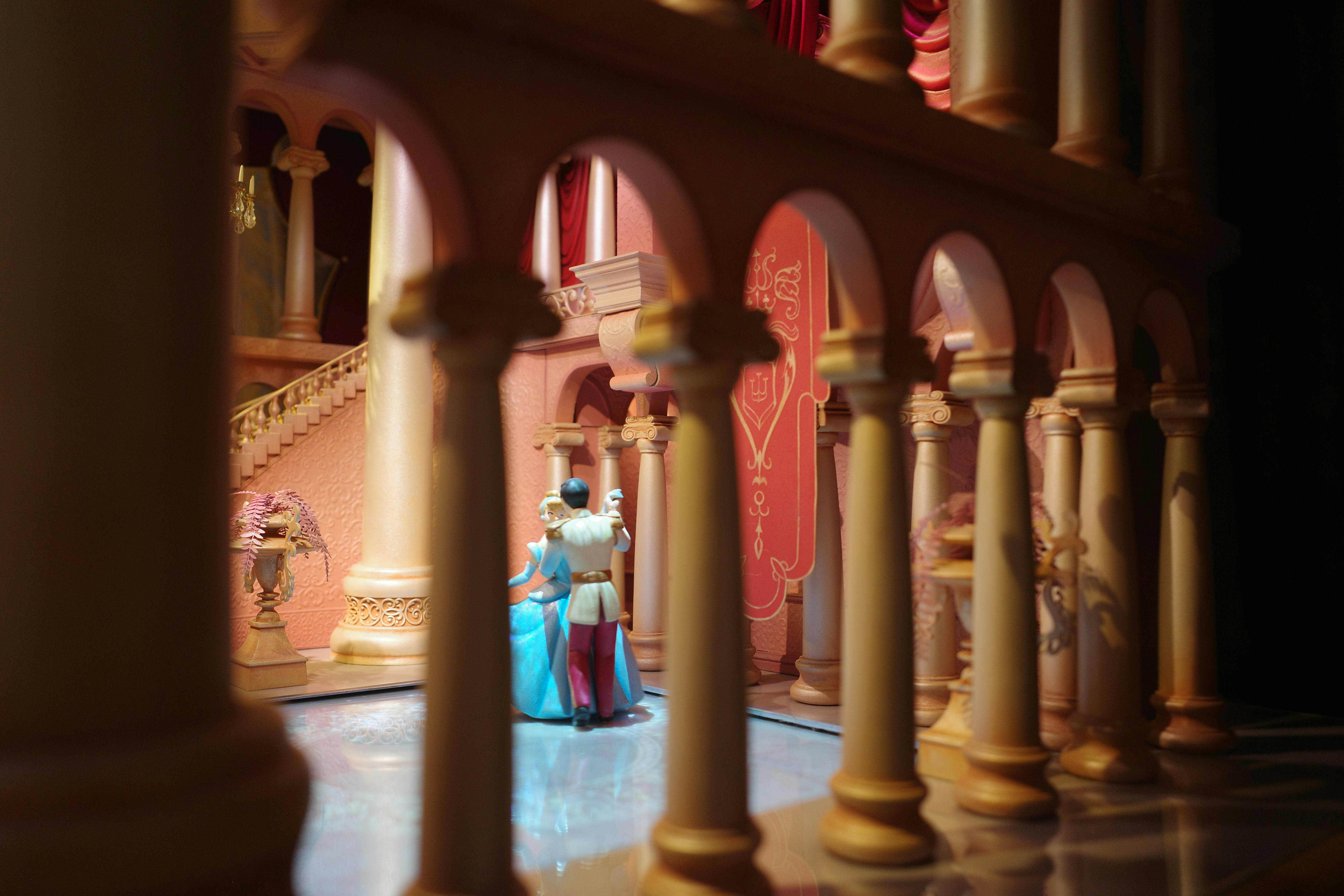 Blue-dressed duet in an amber miniature ballroom