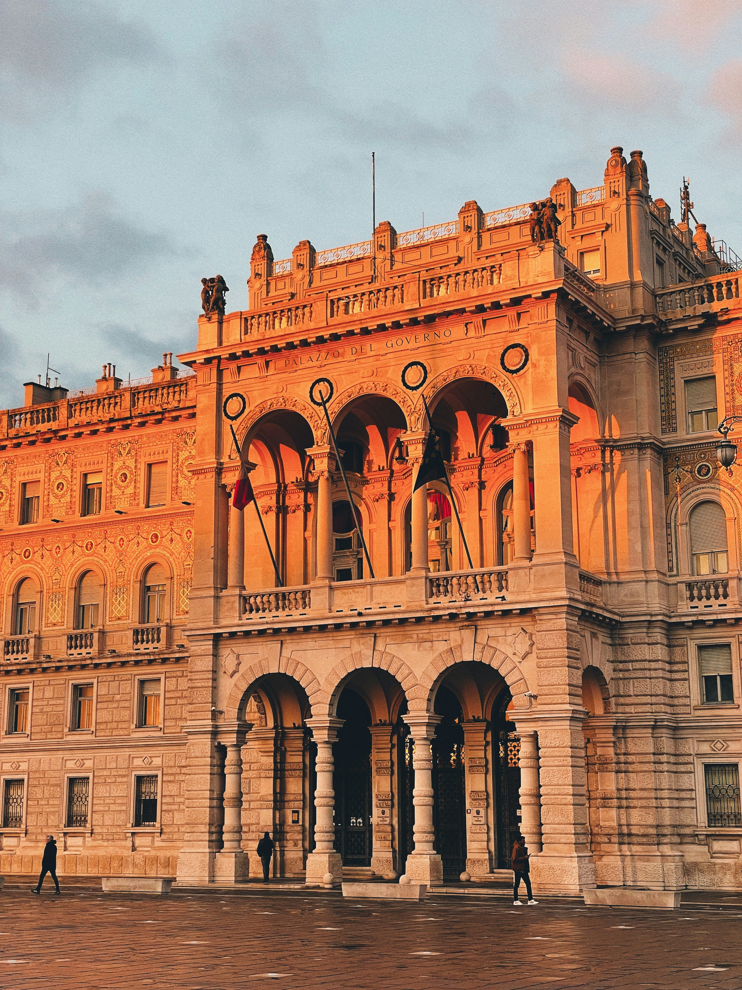 Sunlit Arcades: Central Facade of a Historic Building at Golden Hour