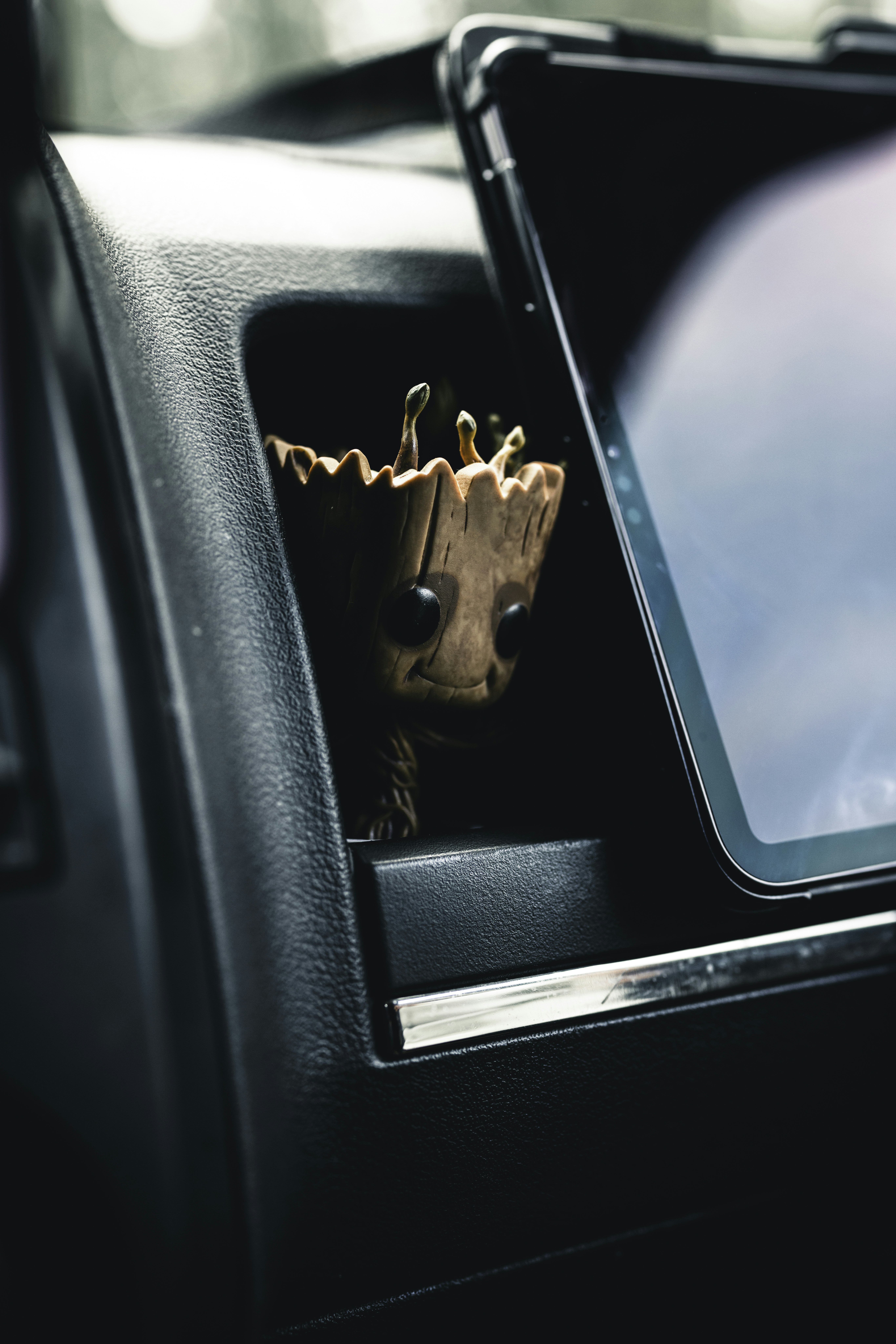 Baby Groot Peeks From the Car's Center Console