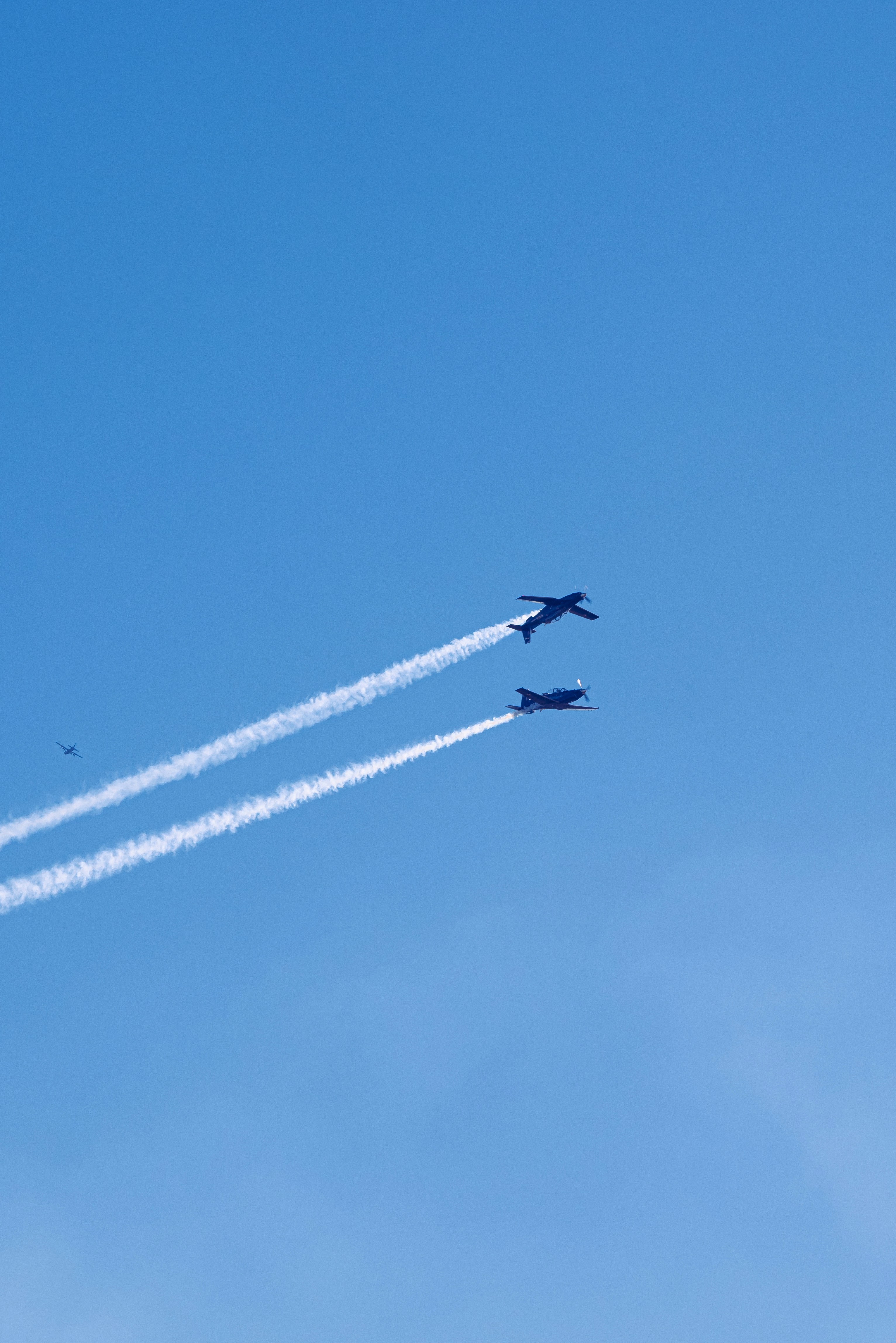 Two jets flying in opposite directions in a blue sky photo – Free Blue ...