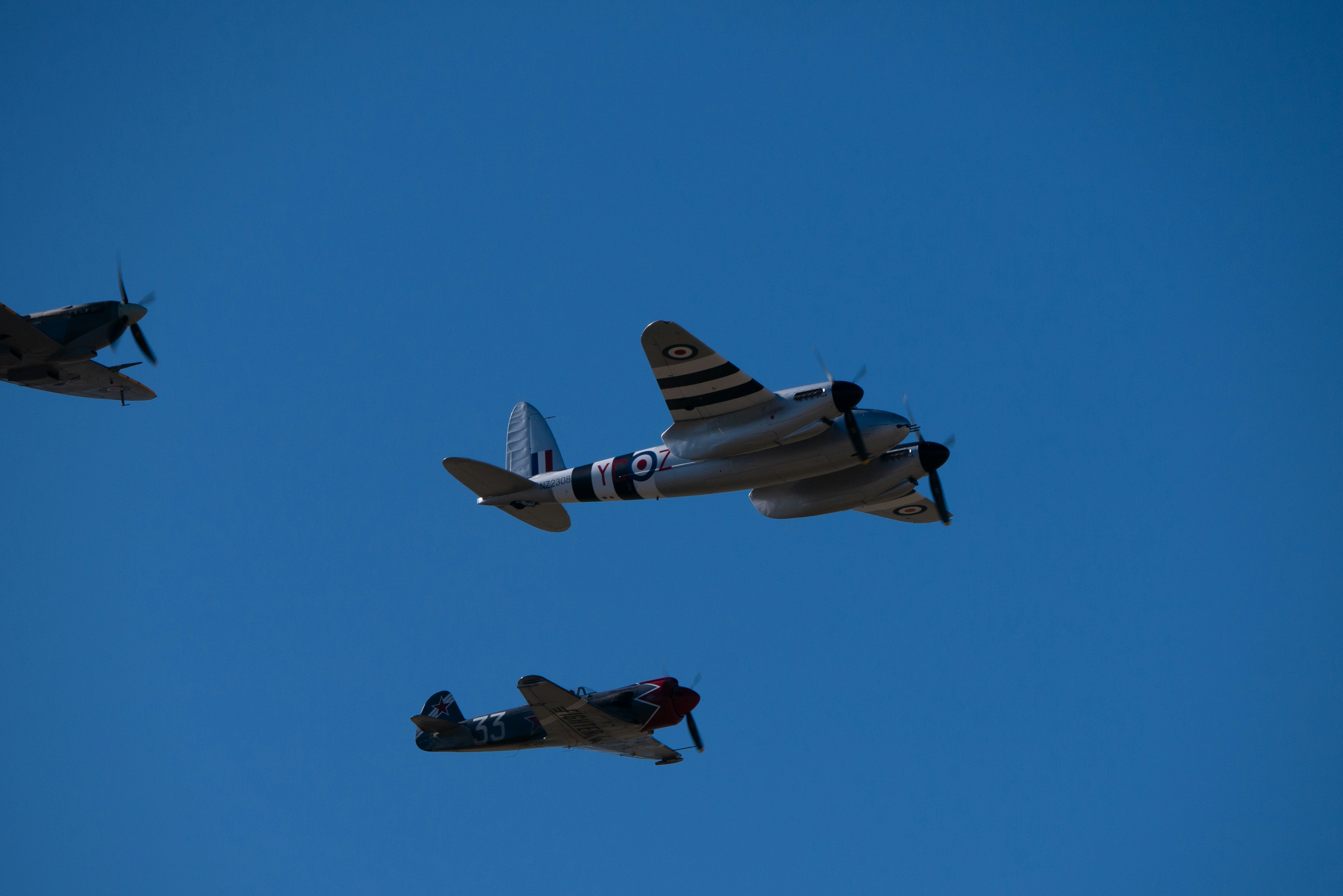 Three planes flying in the air with a blue sky behind them photo – Free ...