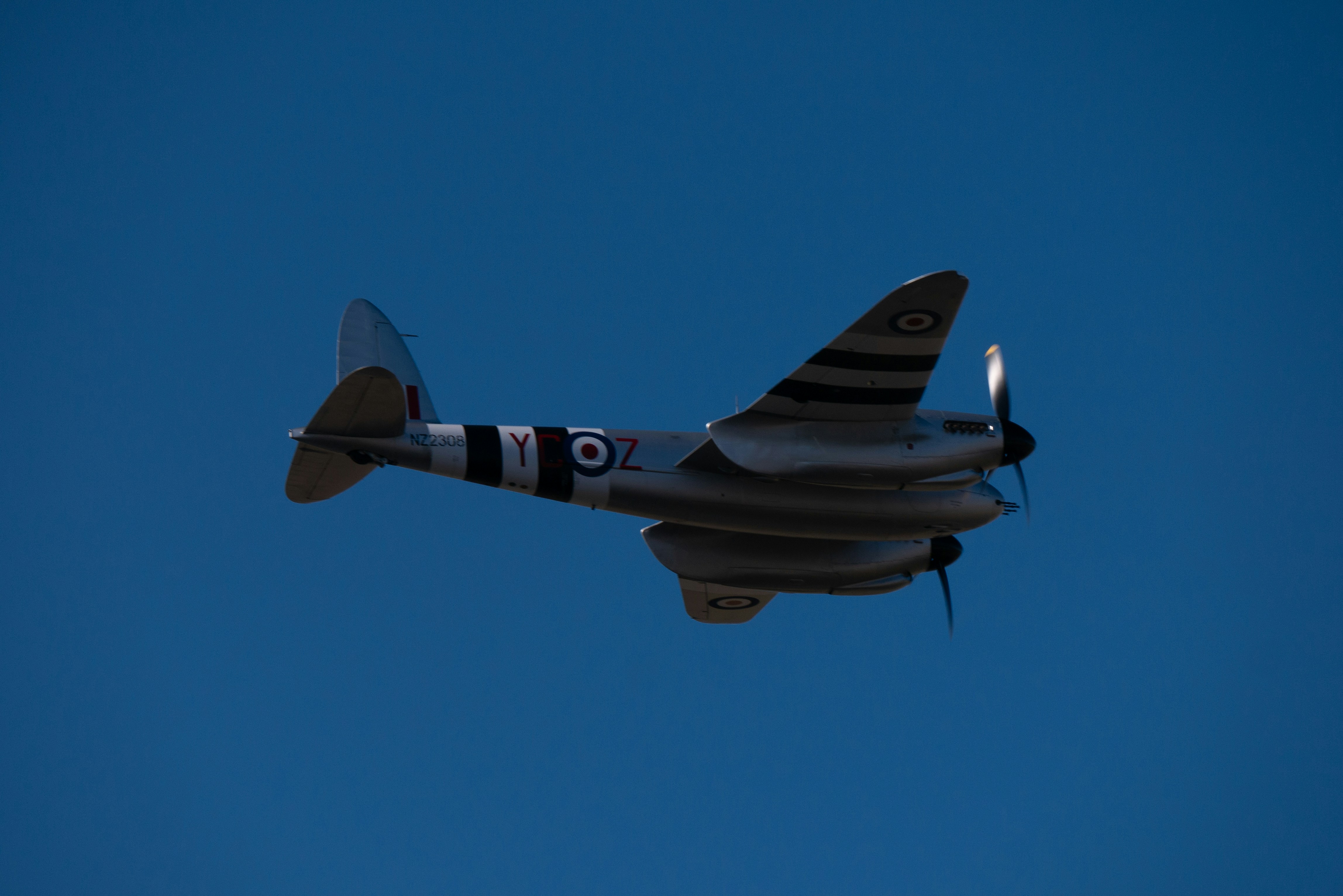 A small airplane flying through a blue sky photo – Free Warbirds over ...