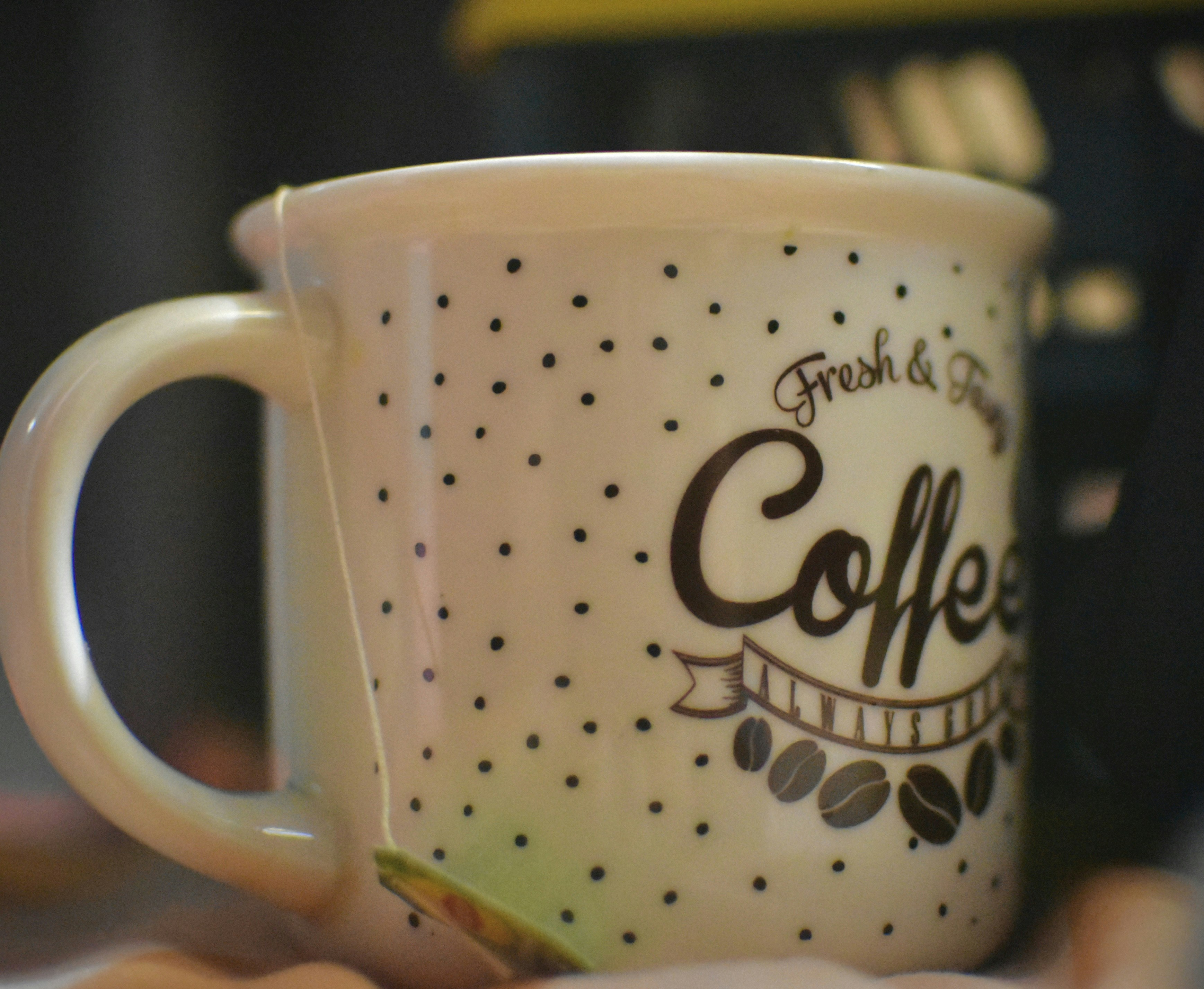Polka-dotted coffee mug: warm branding in a softly blurred scene