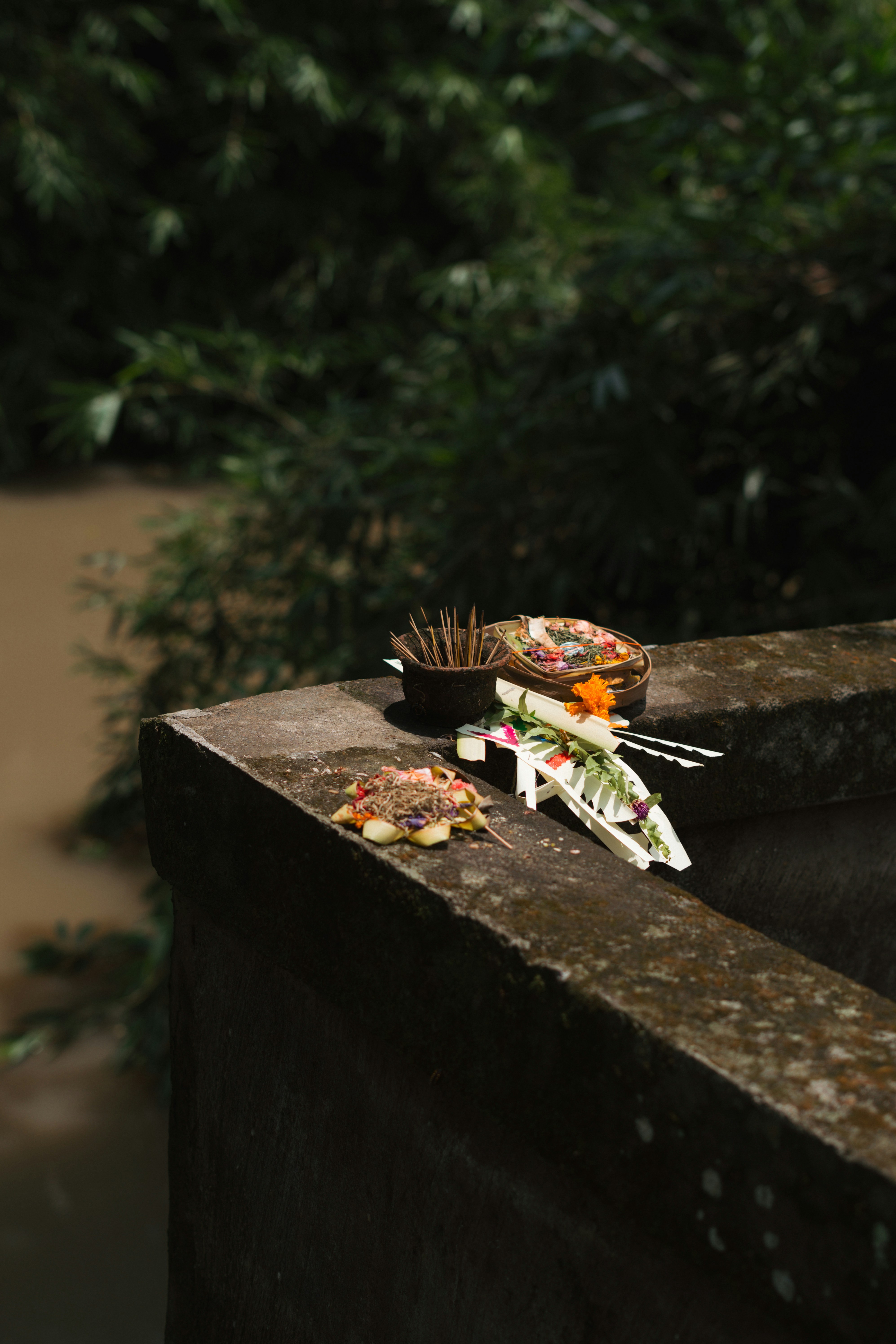 Balinese offerings | a bunch of flowers that are sitting on a ledge