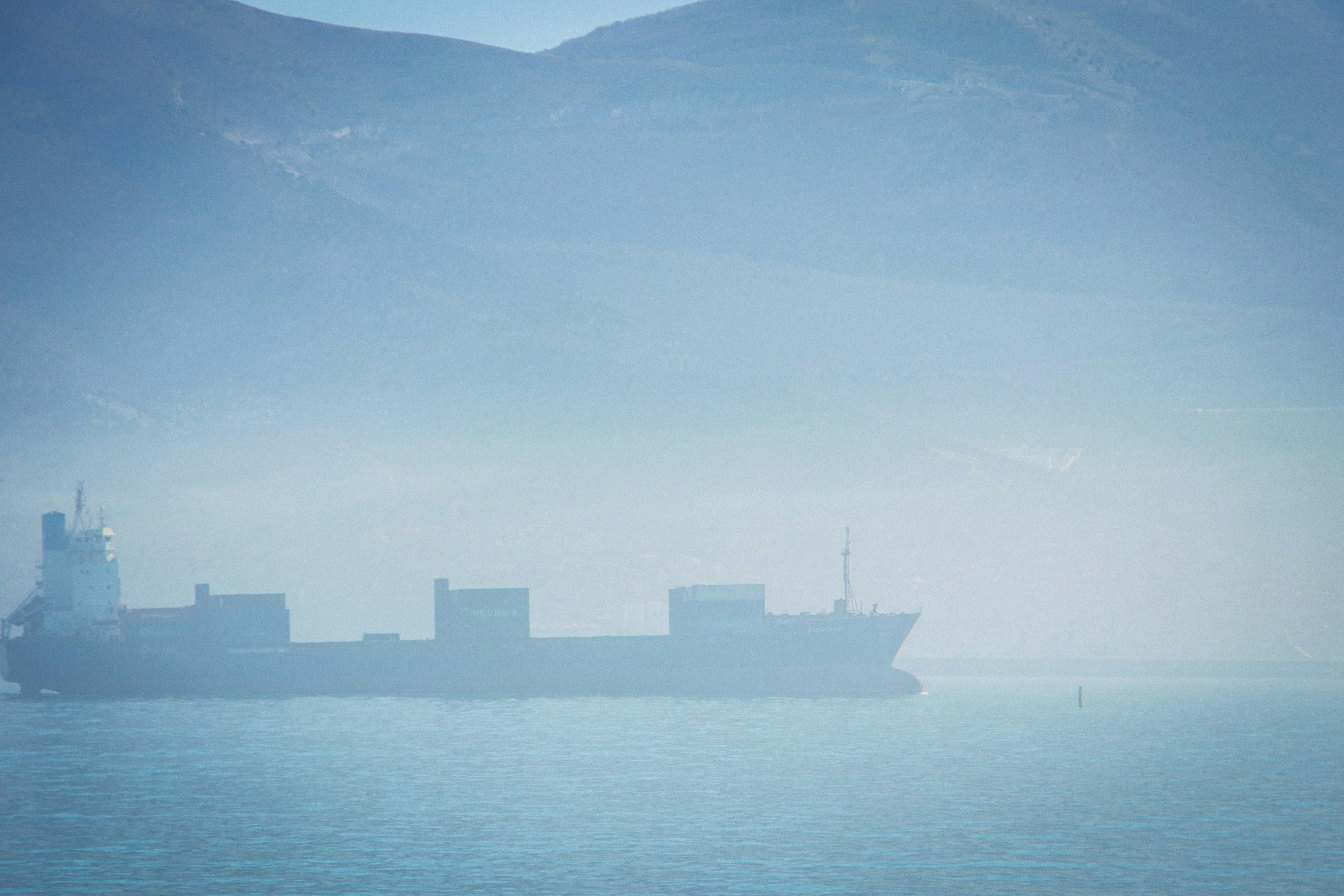 a large cargo ship in the middle of a body of water