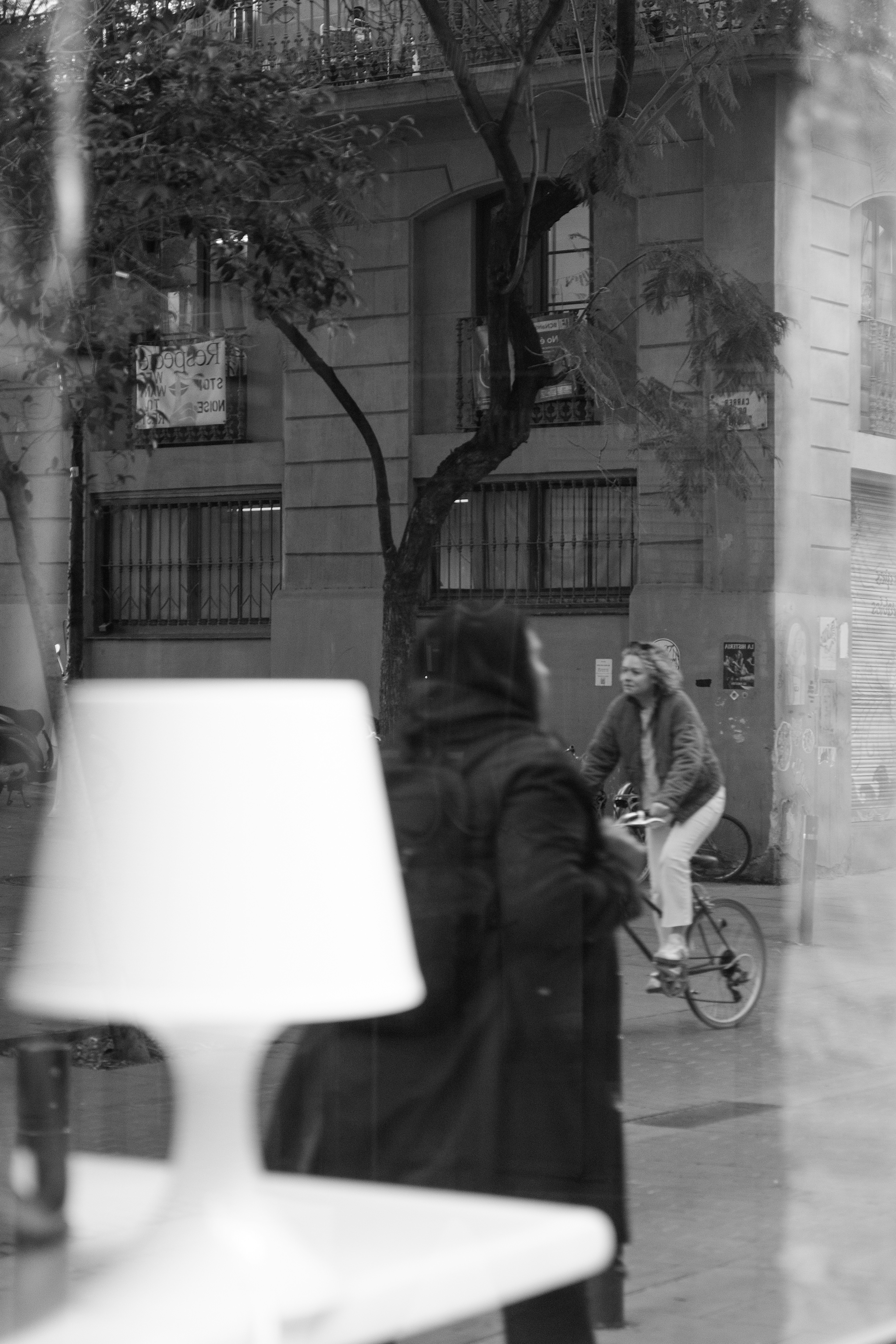 Glass, Motion, and Urban Quiet: A Cyclist in Soft Focus