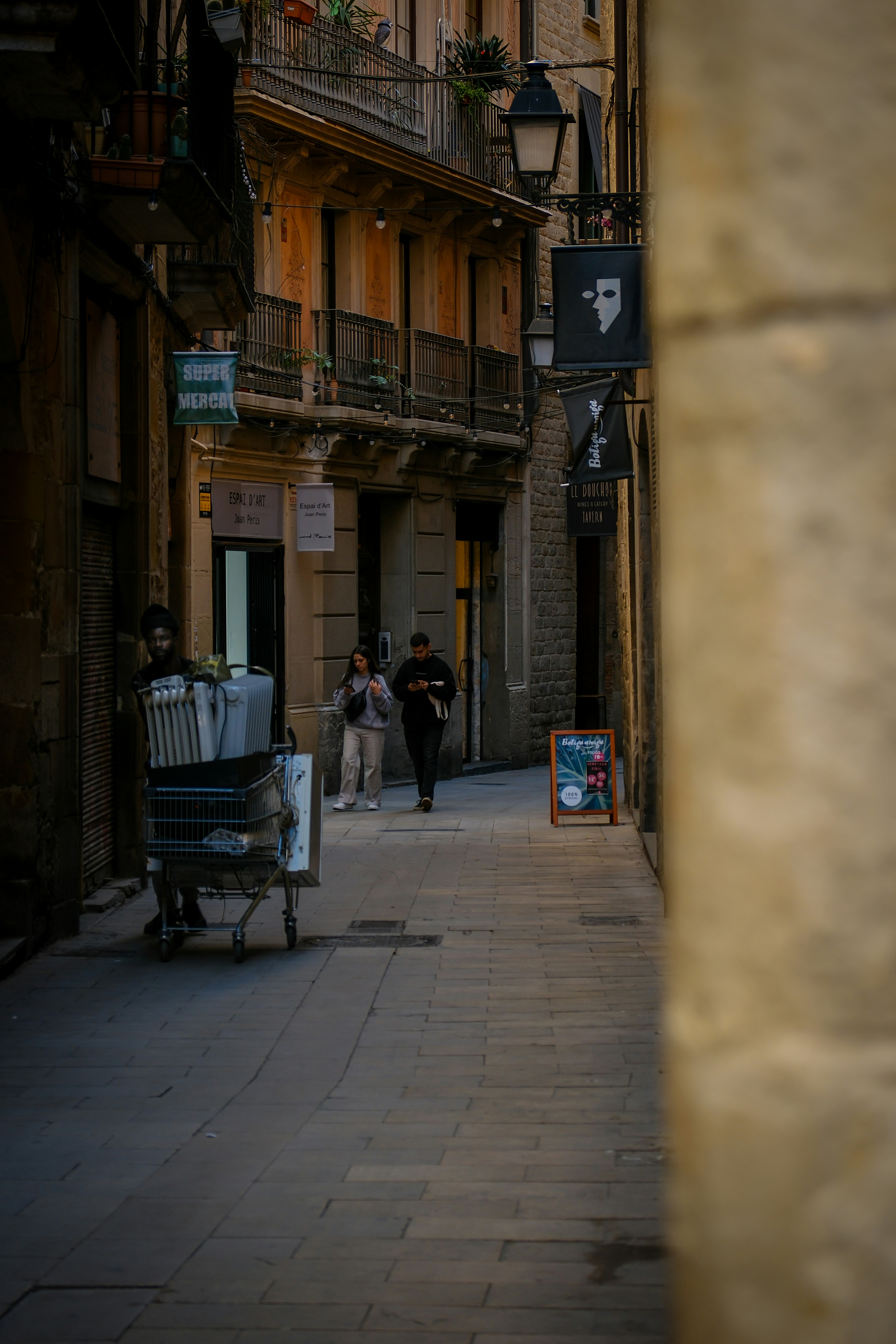 Quiet Parallel: Two Passersby in a Sunlit European Alley