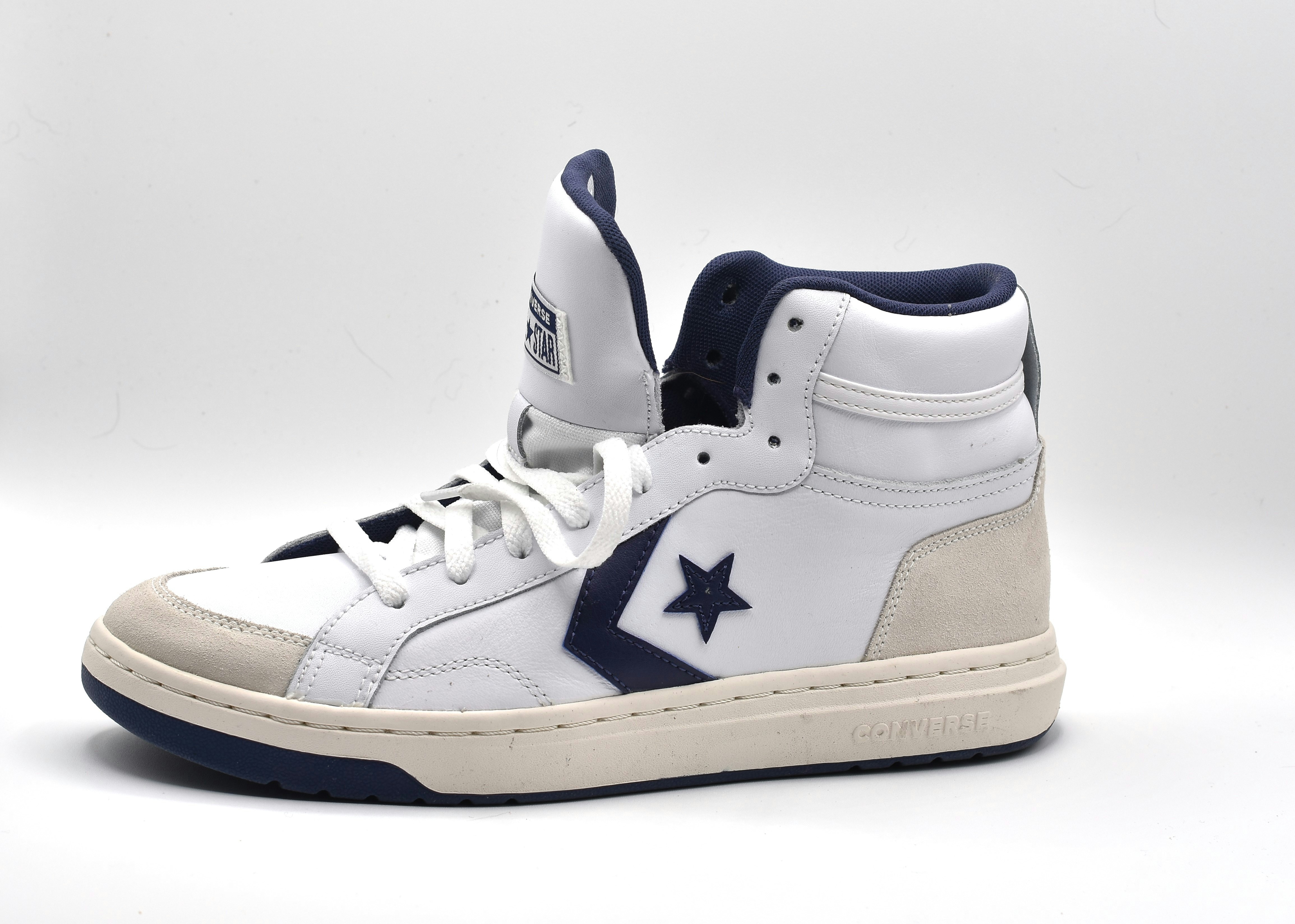 Side Profile: White High-Top Sneaker with Navy Star and Tan Toe Cap