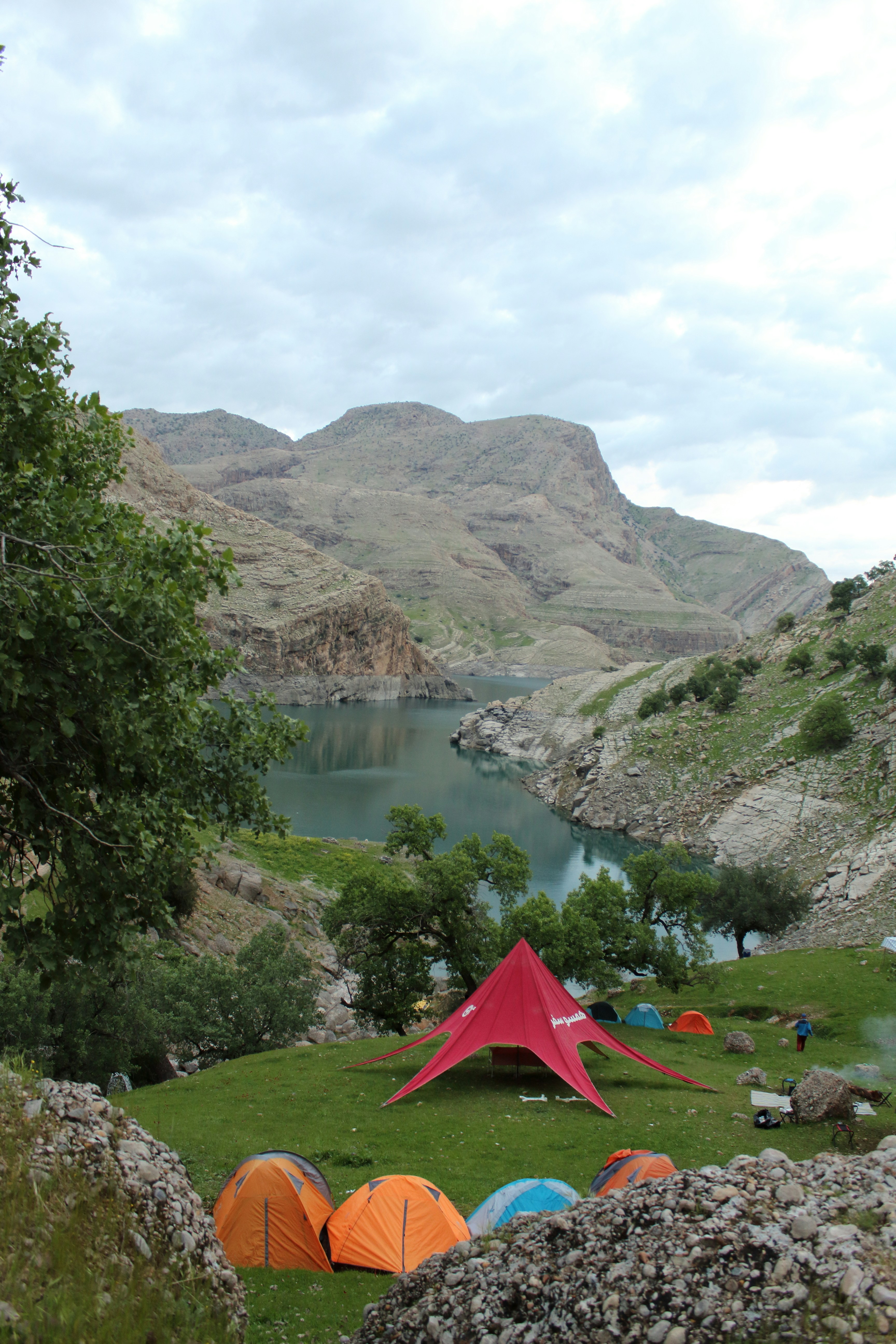 a group of tents sitting on top of a lush green hillside