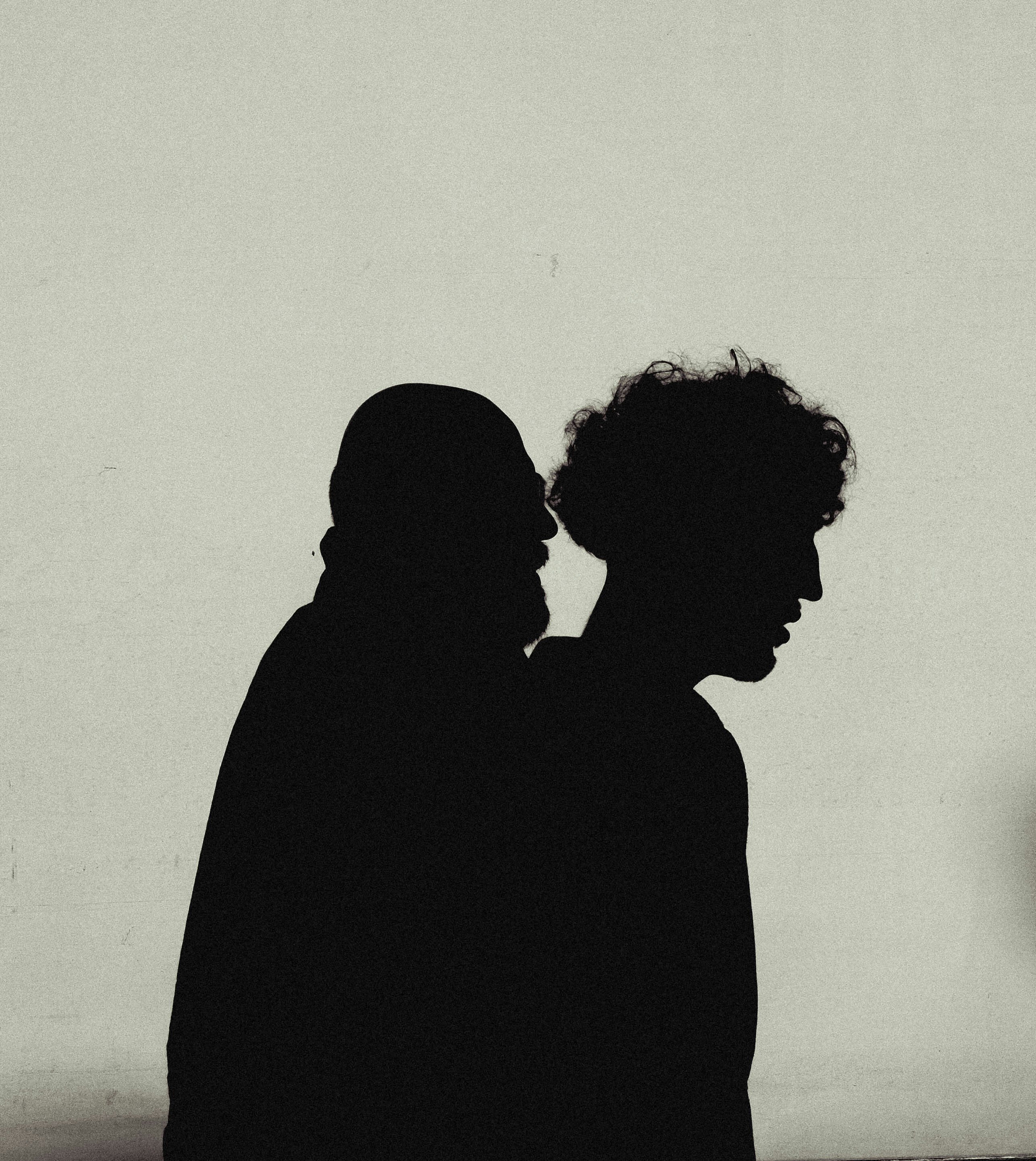 Two Silhouettes in a Grainy Backdrop