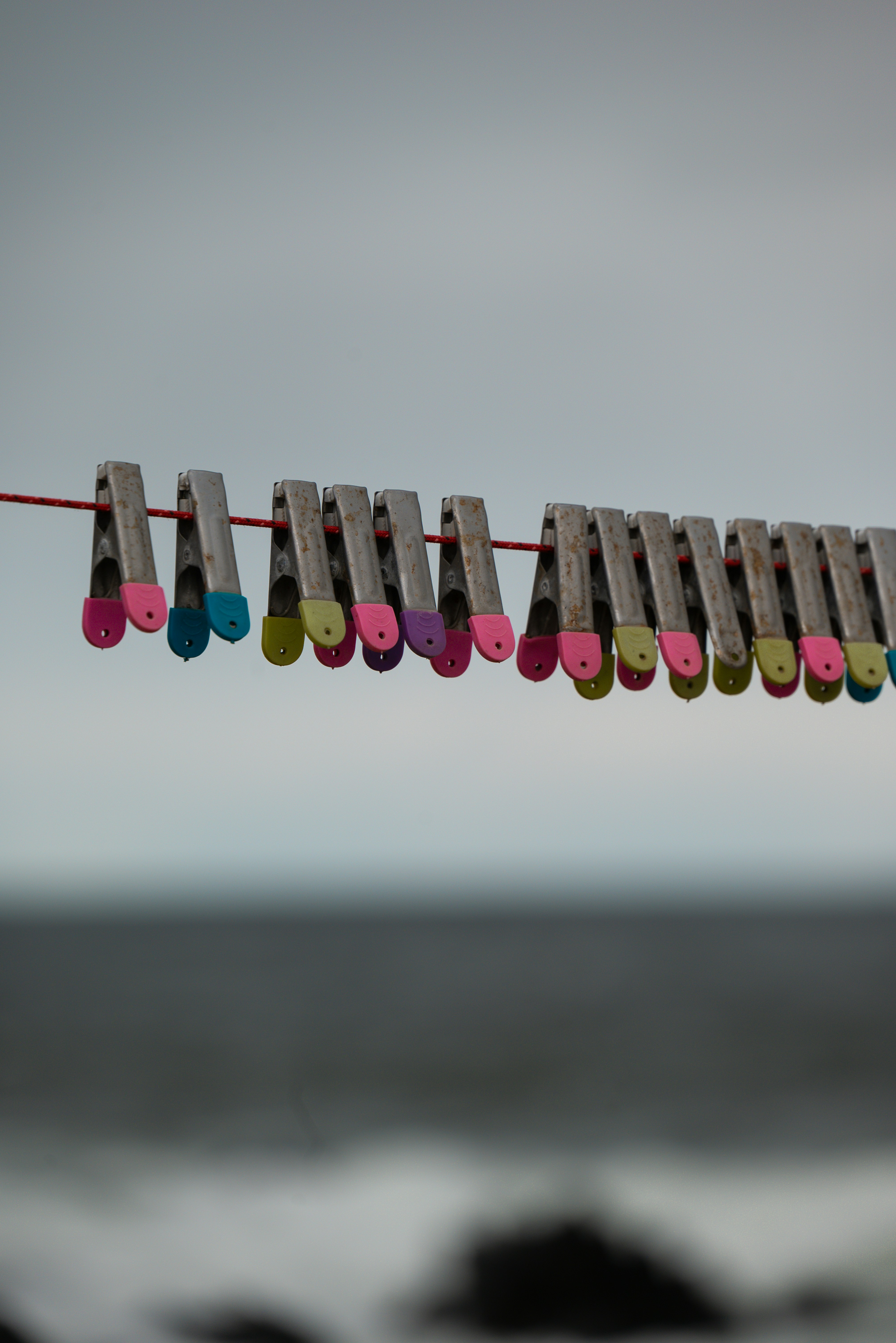 A row of clothes pins hanging from a clothes line photo – Free Pegs ...