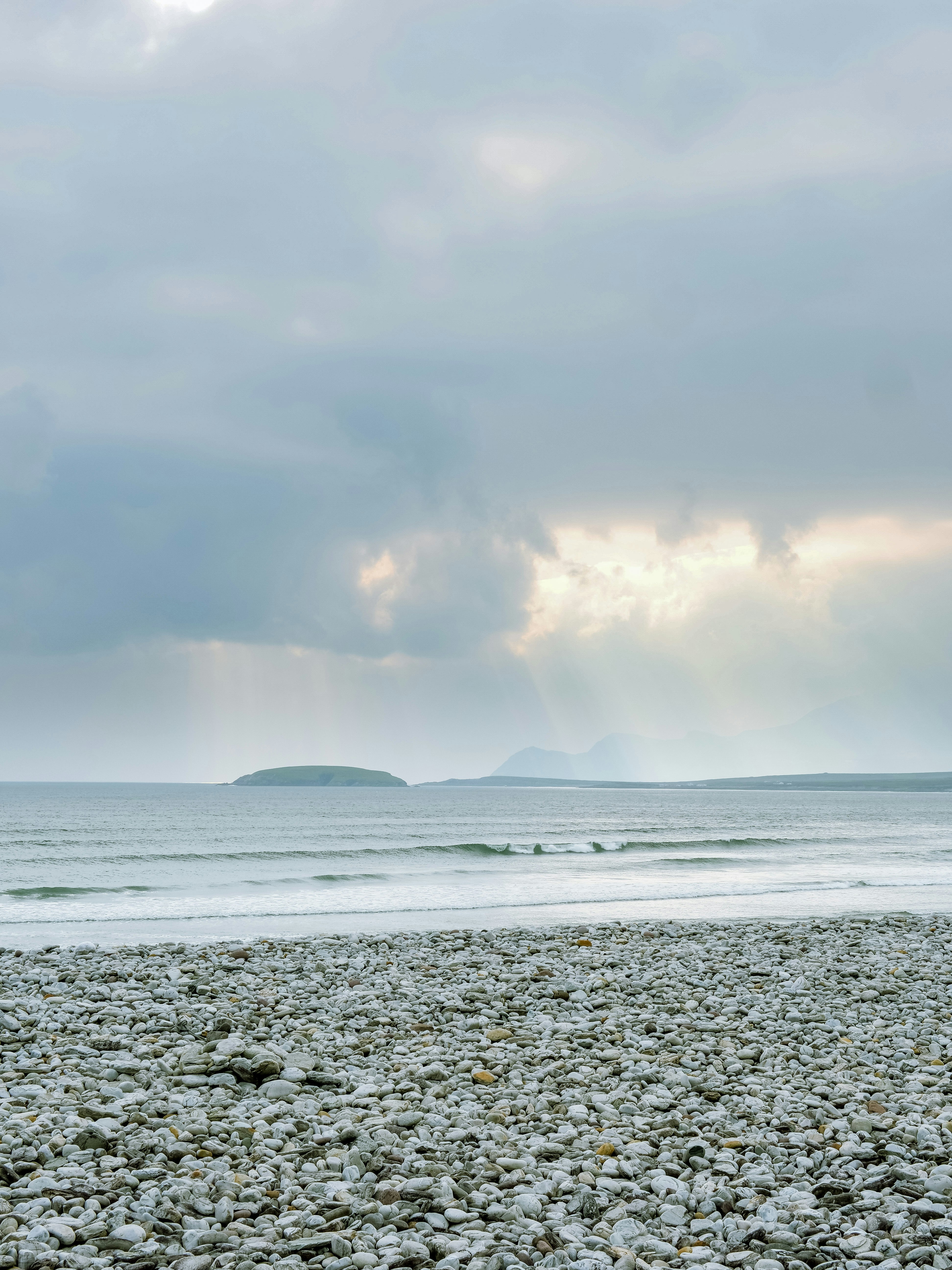 Beneath Raining Light: Pebble Shore and Quiet Sea
