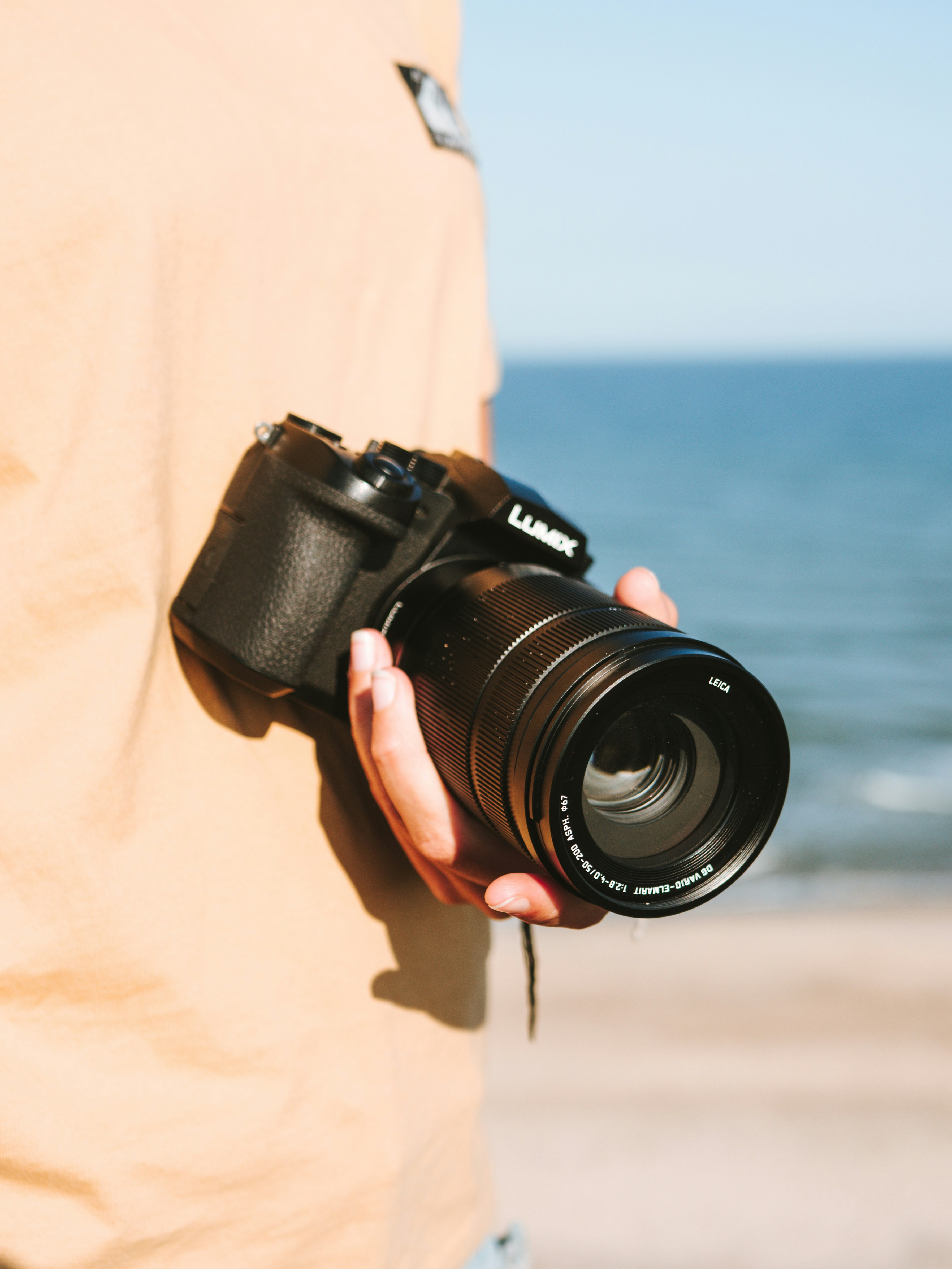 Coastal Click: A Sunlit Moment with a Handheld Lumix