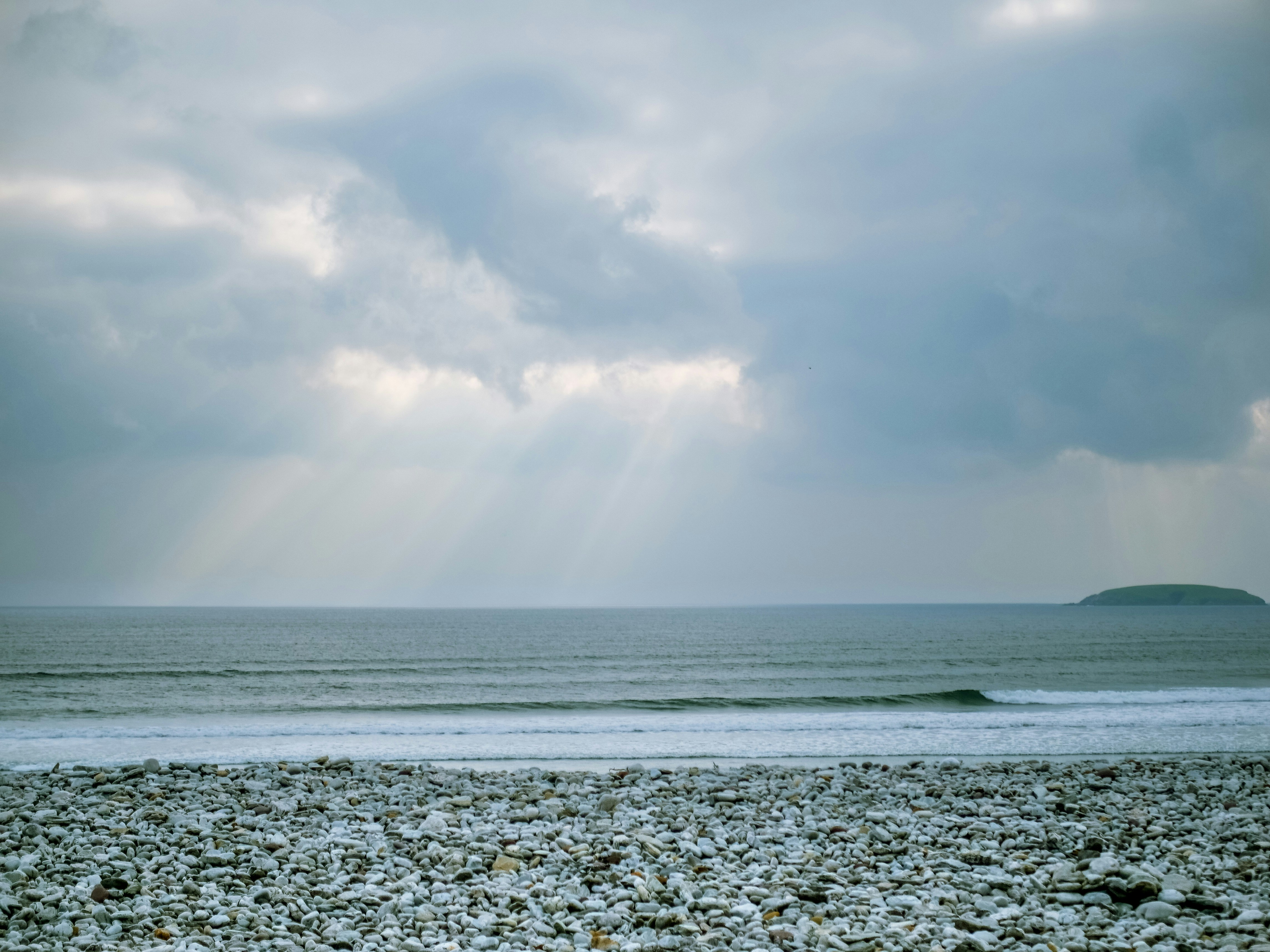 Sunbeams over a Pebble Shore: a Quiet Confluence of Sea and Sky