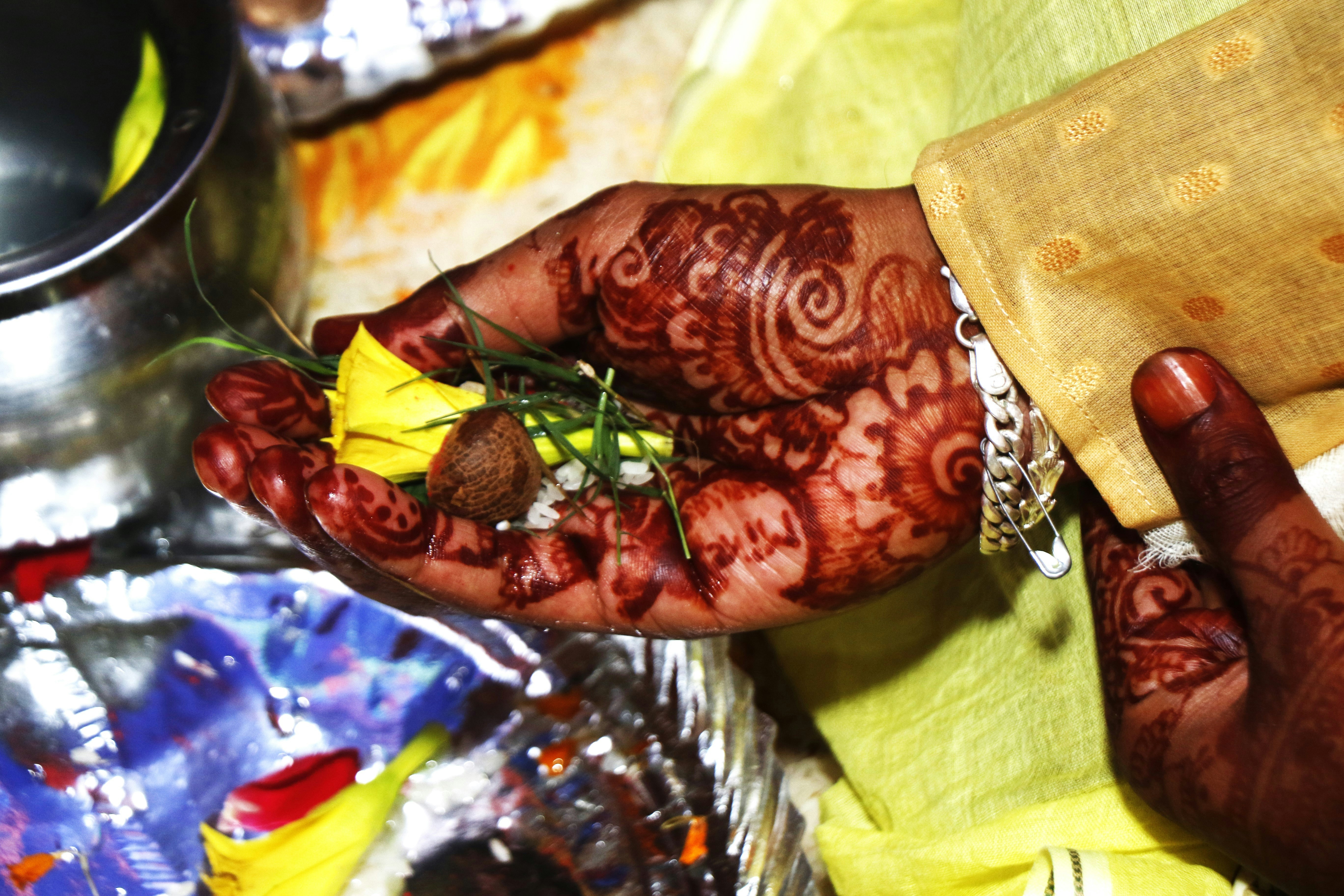 A person with henna on their hand holding a piece of food photo – Free ...