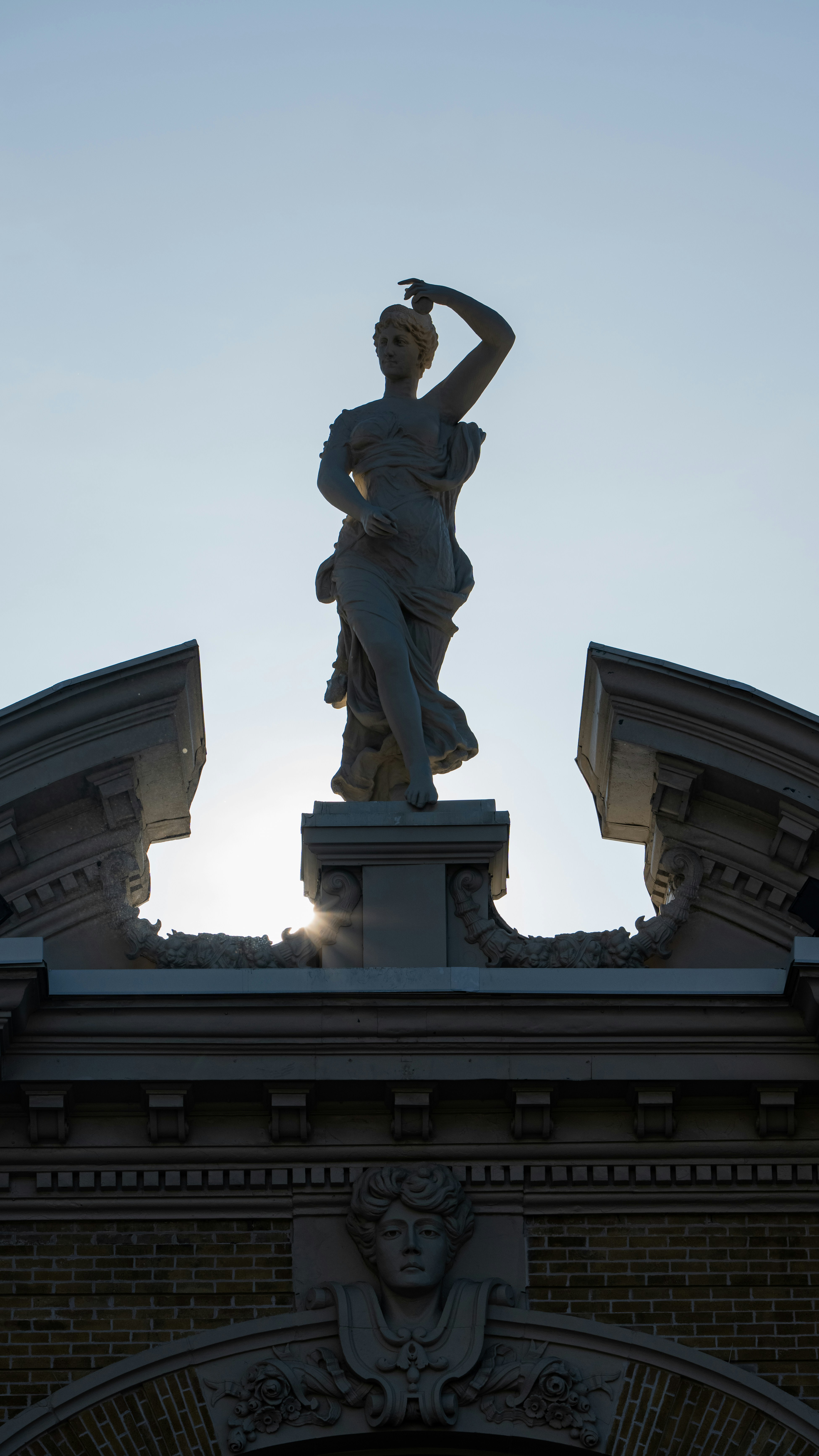 A statue of a woman on top of a building photo – Free Sleeves Image on ...