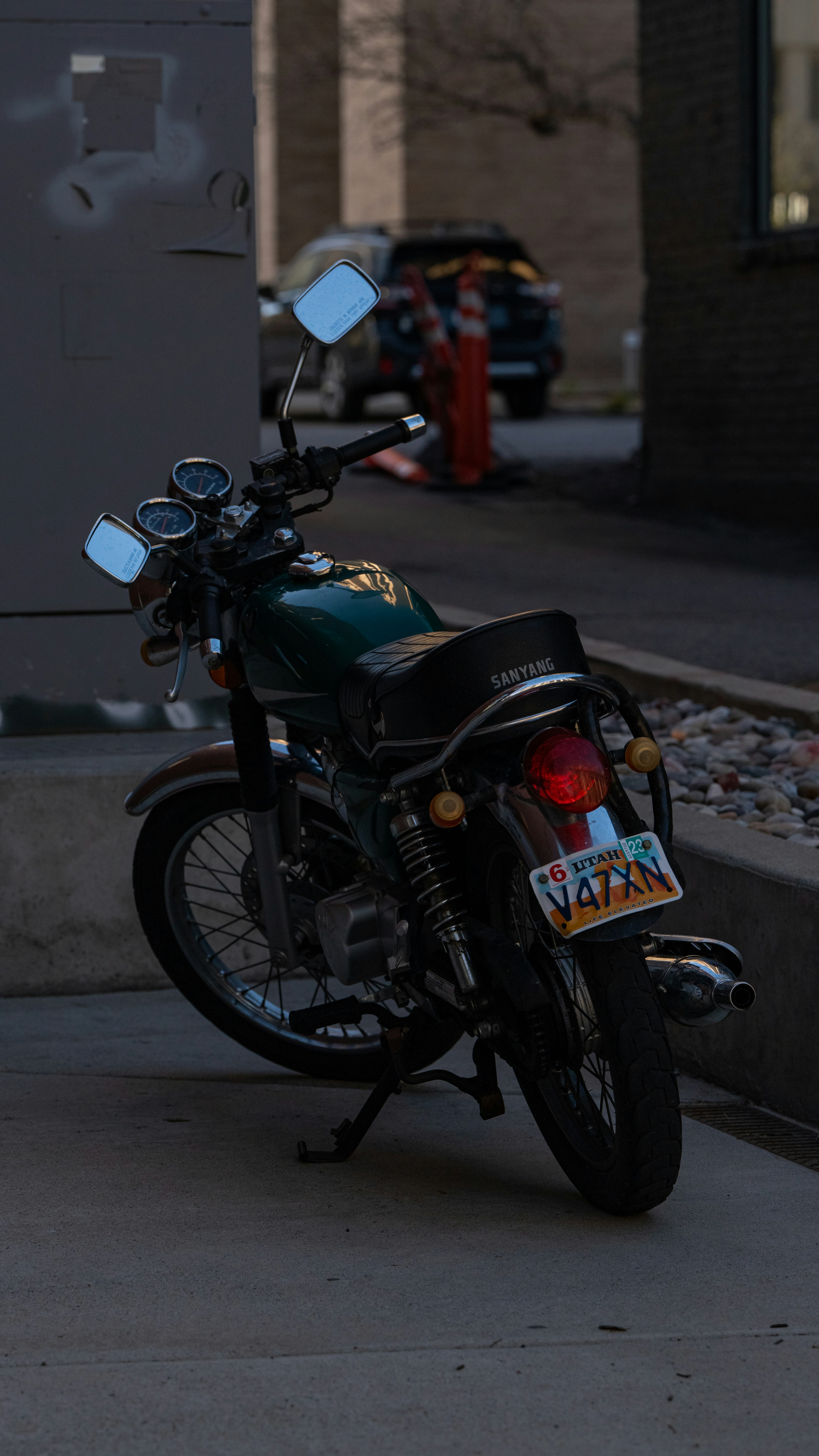 Teal Vintage Motorcycle Resting in a Dim Urban Alley at Dusk