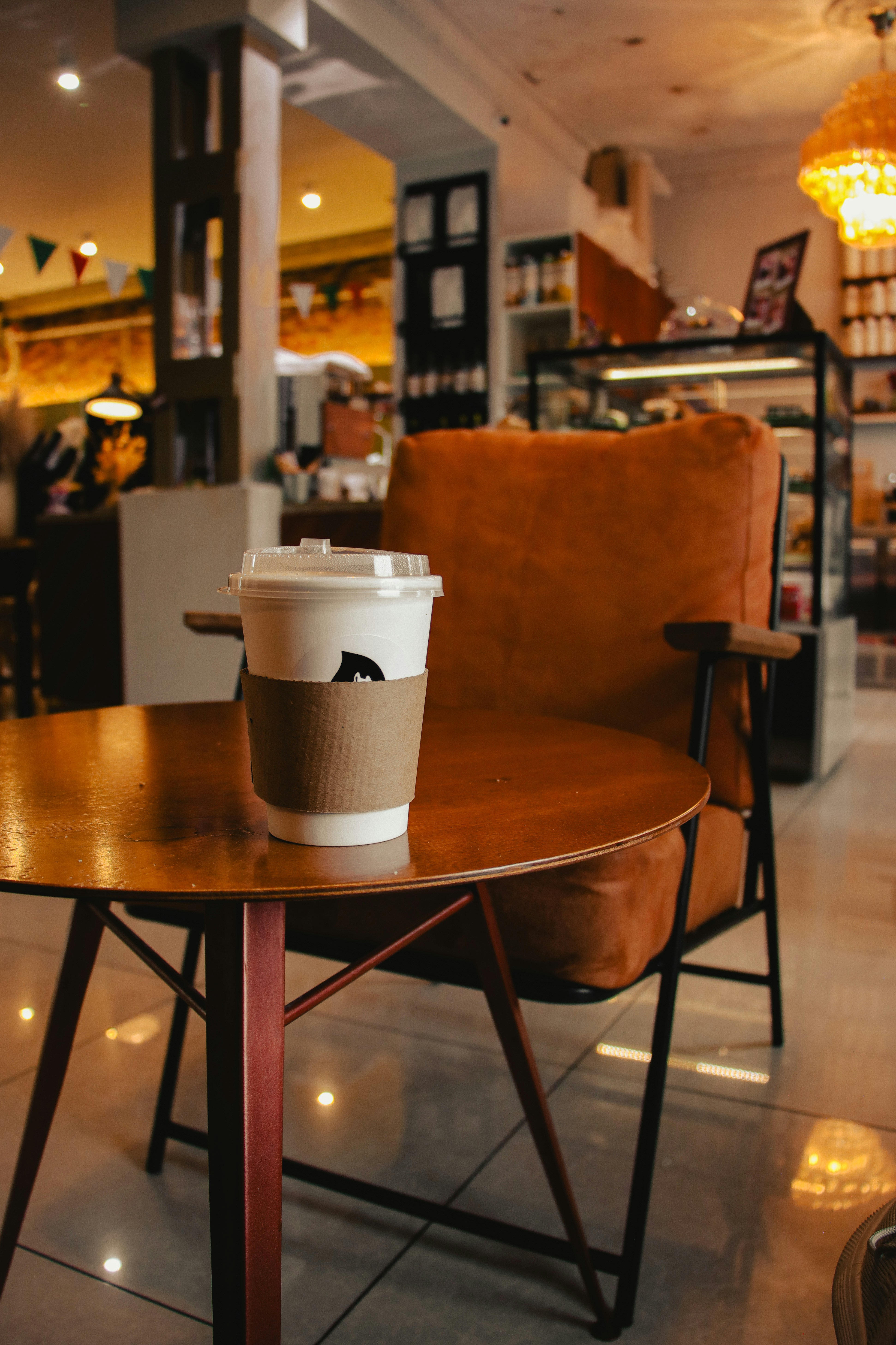 A coffee cup sitting on top of a wooden table photo – Free Food Image ...