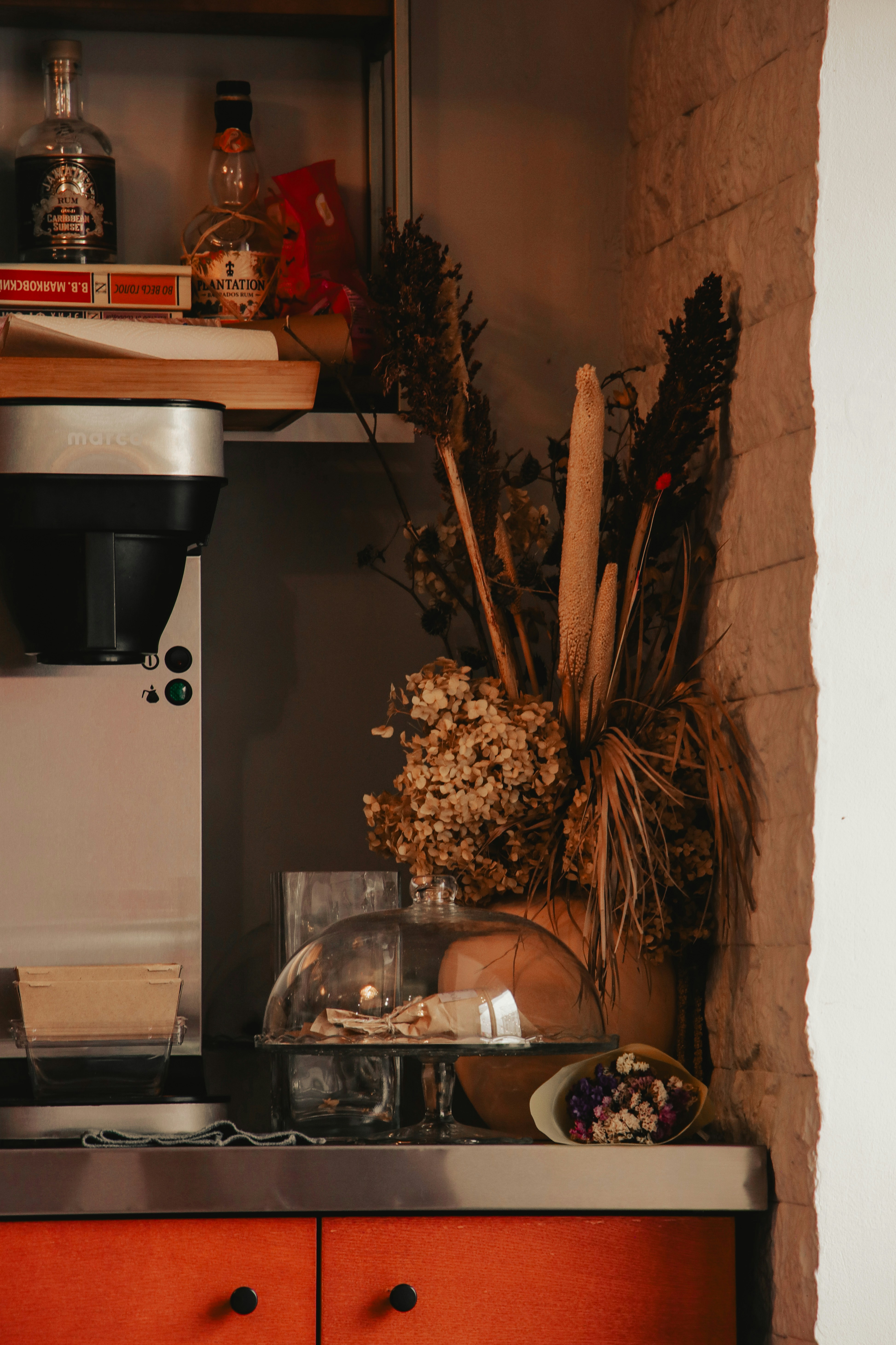 Quiet Heat: A Vintage Espresso Machine Nestled Among Dried Florals on a Rustic Counter