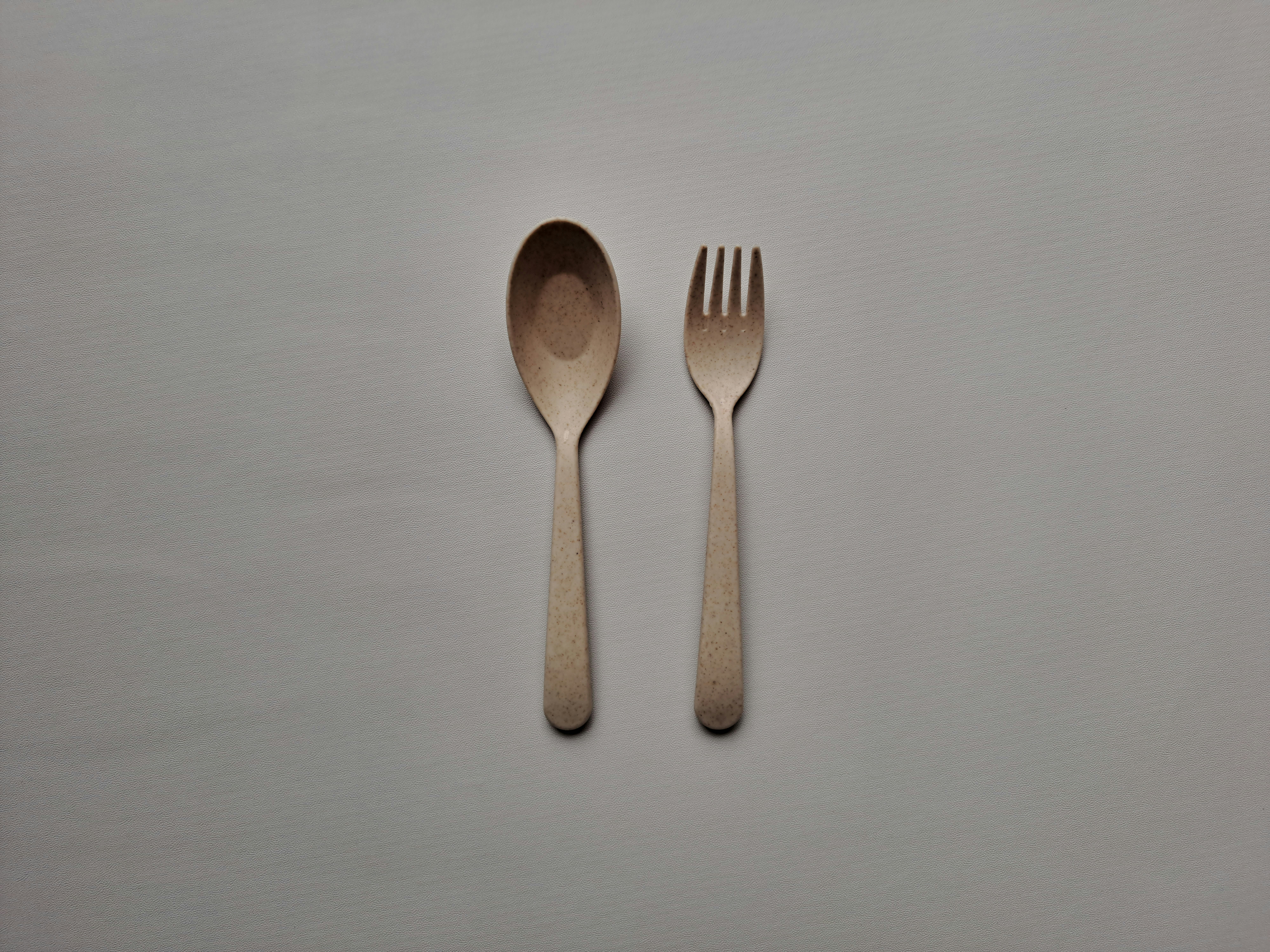 A couple of spoons and a fork on a table photo – Free Fork Image on ...